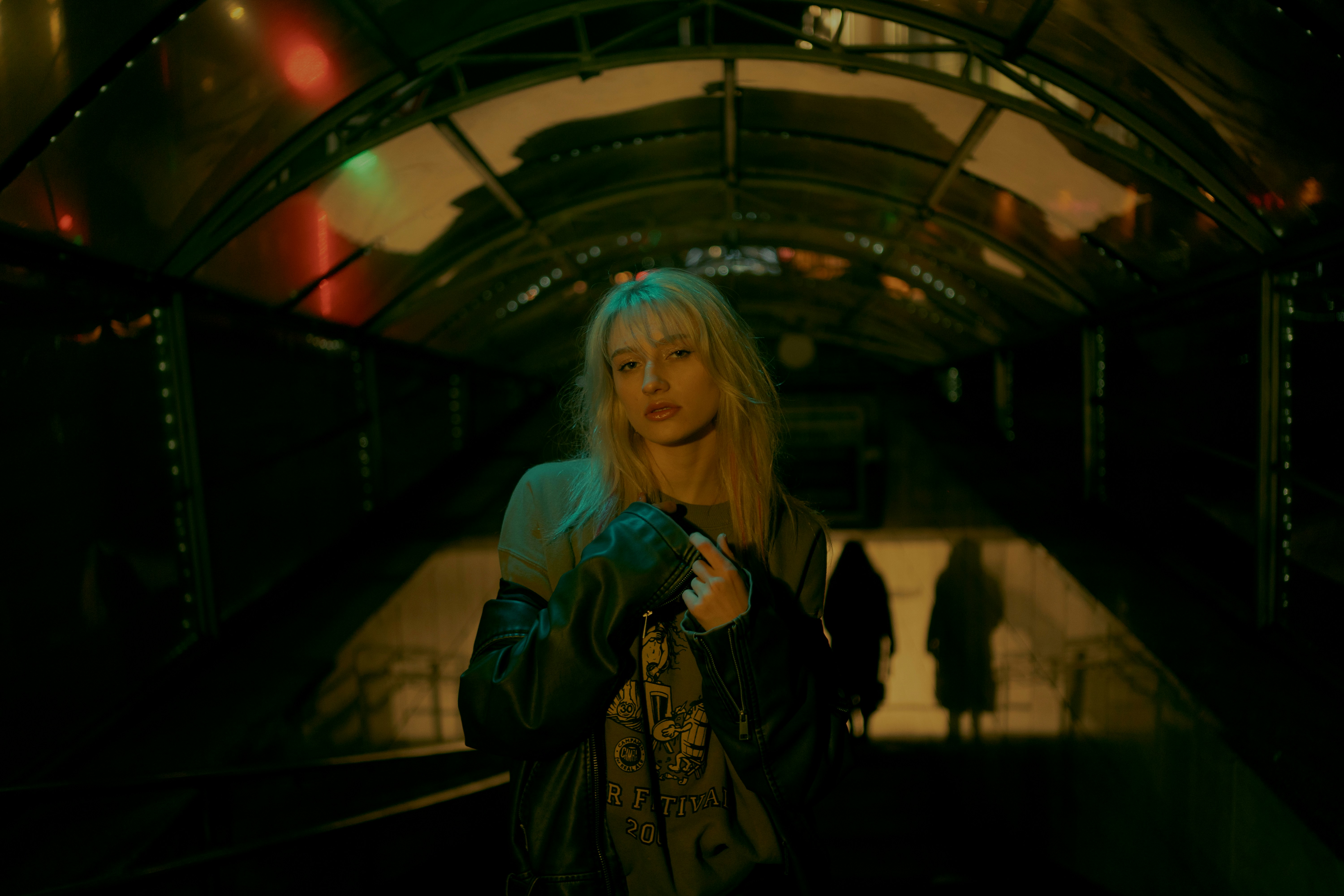 Neon-lit Traveler: A Blonde Portrait Under Glass Arches
