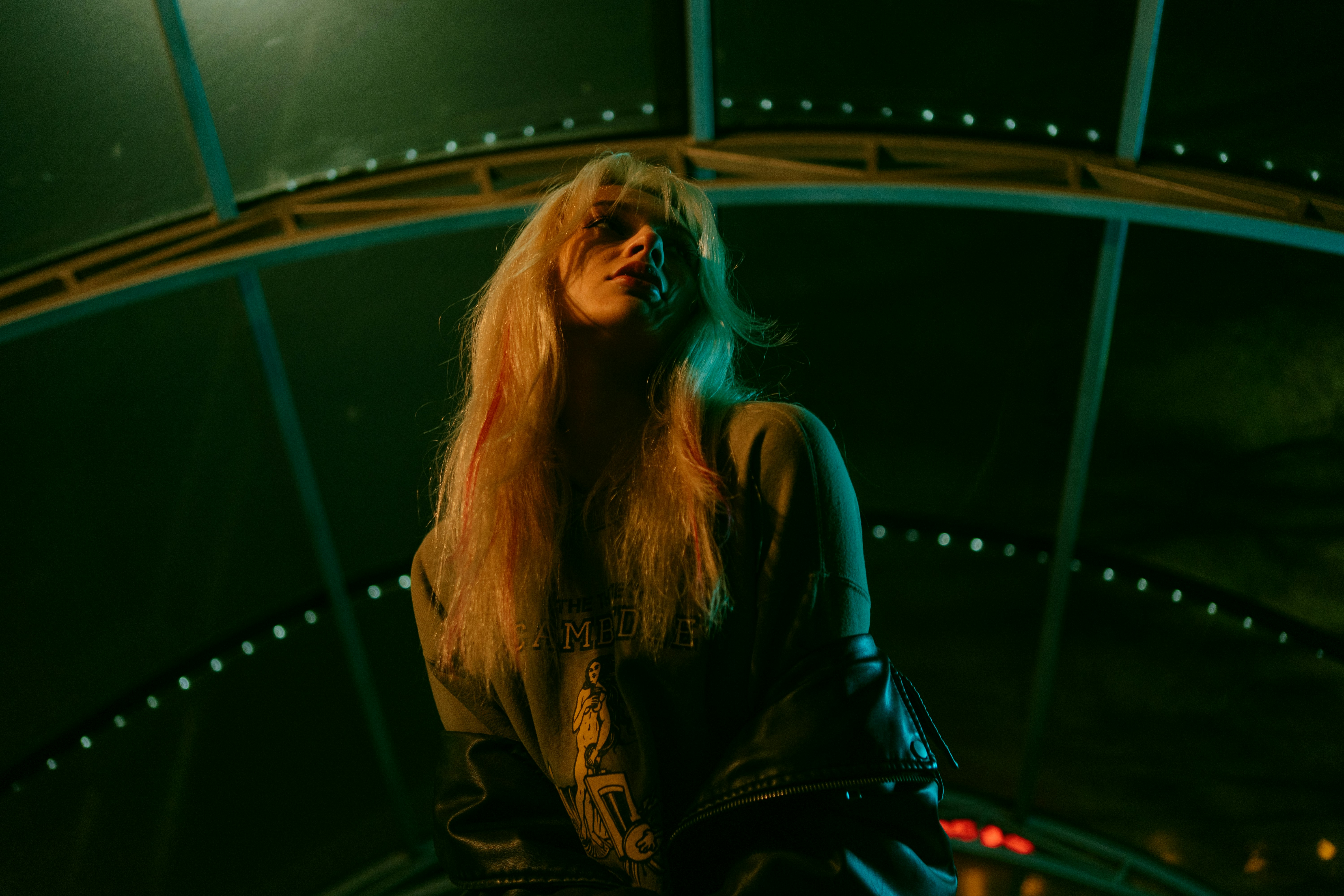 Neon-lit Portrait Under Green Glass Canopy
