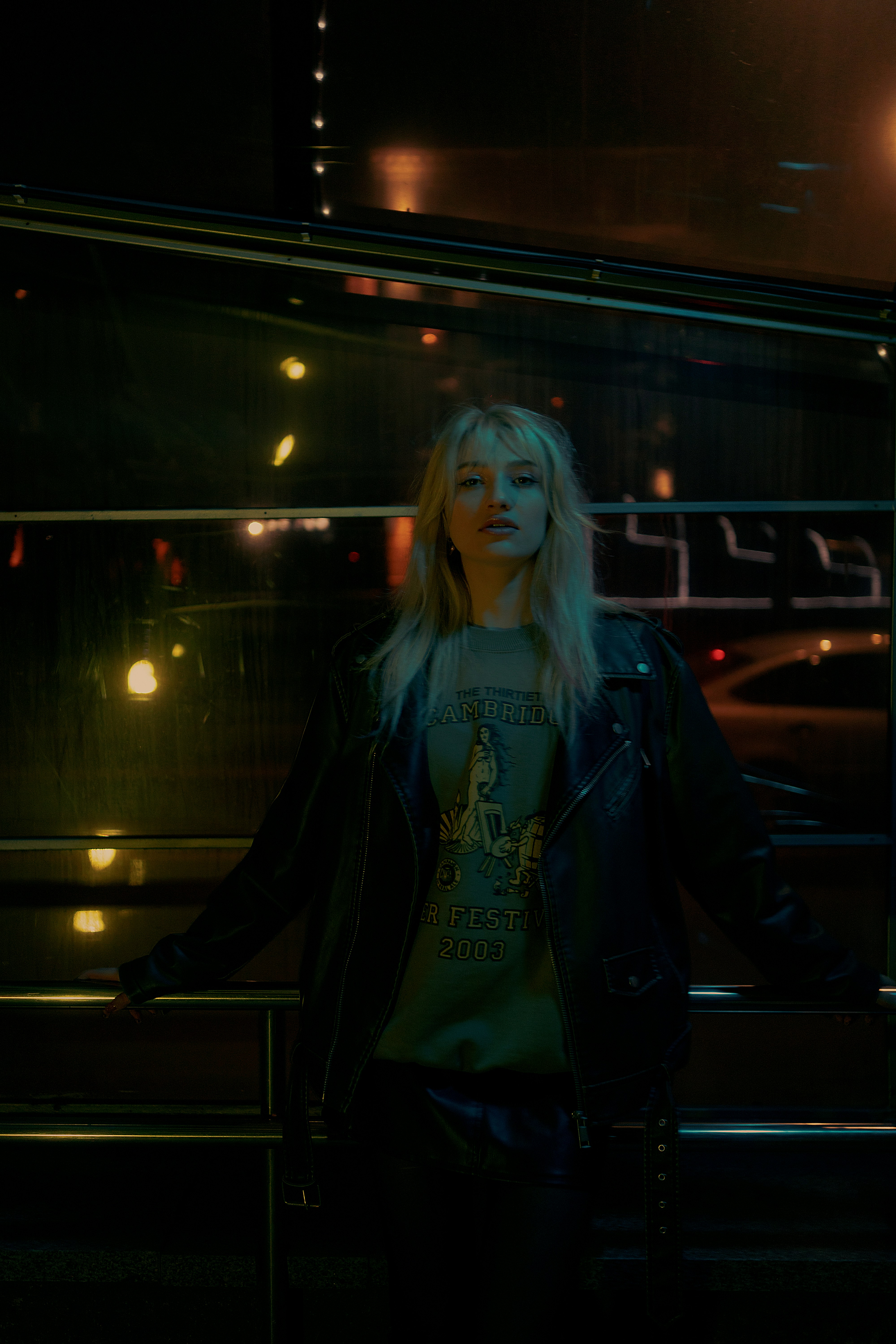 Neon Quiet: A Leather-Clad Figure Under City Glow