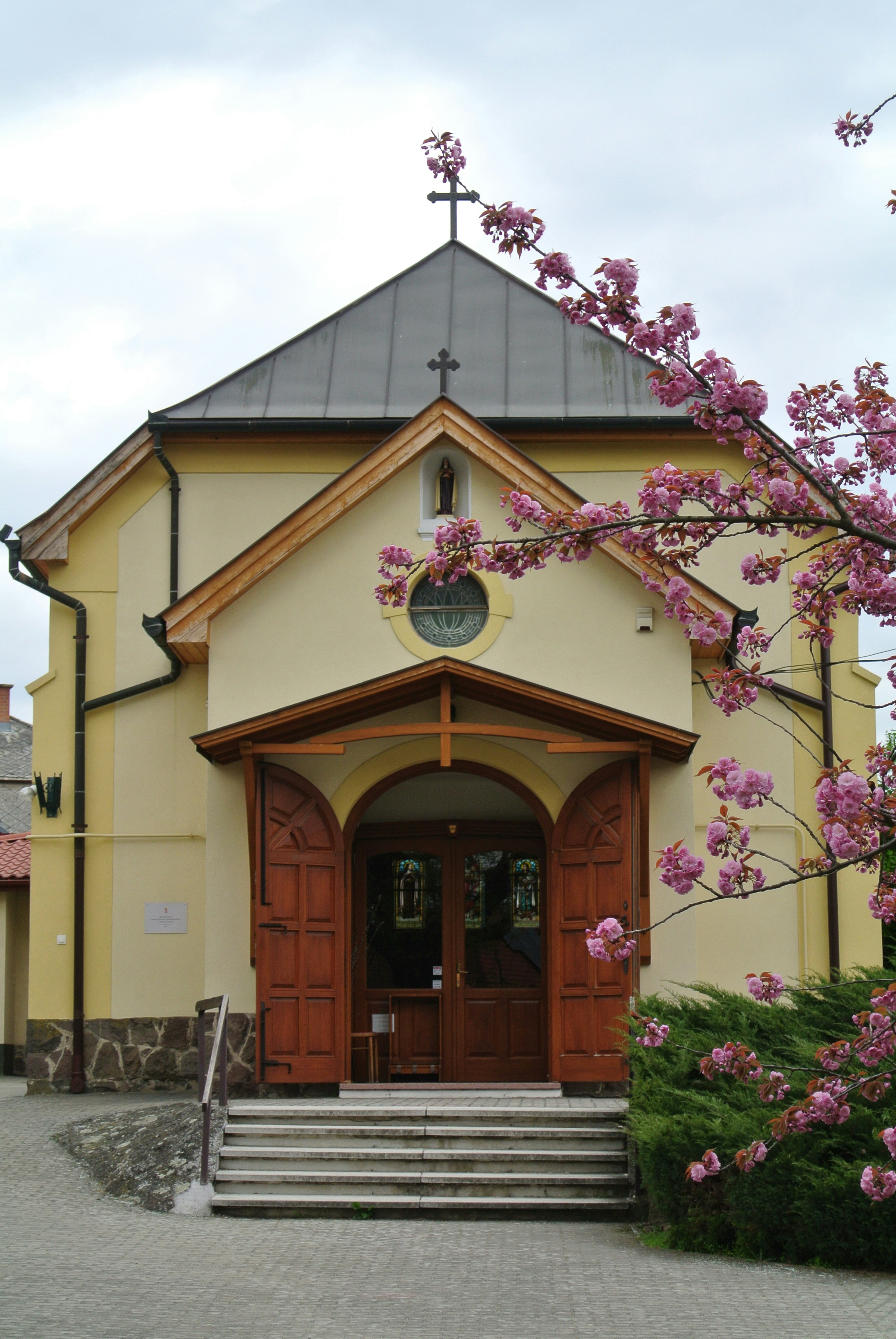 Open-arched Church Doors Framed by Blossoming Branches