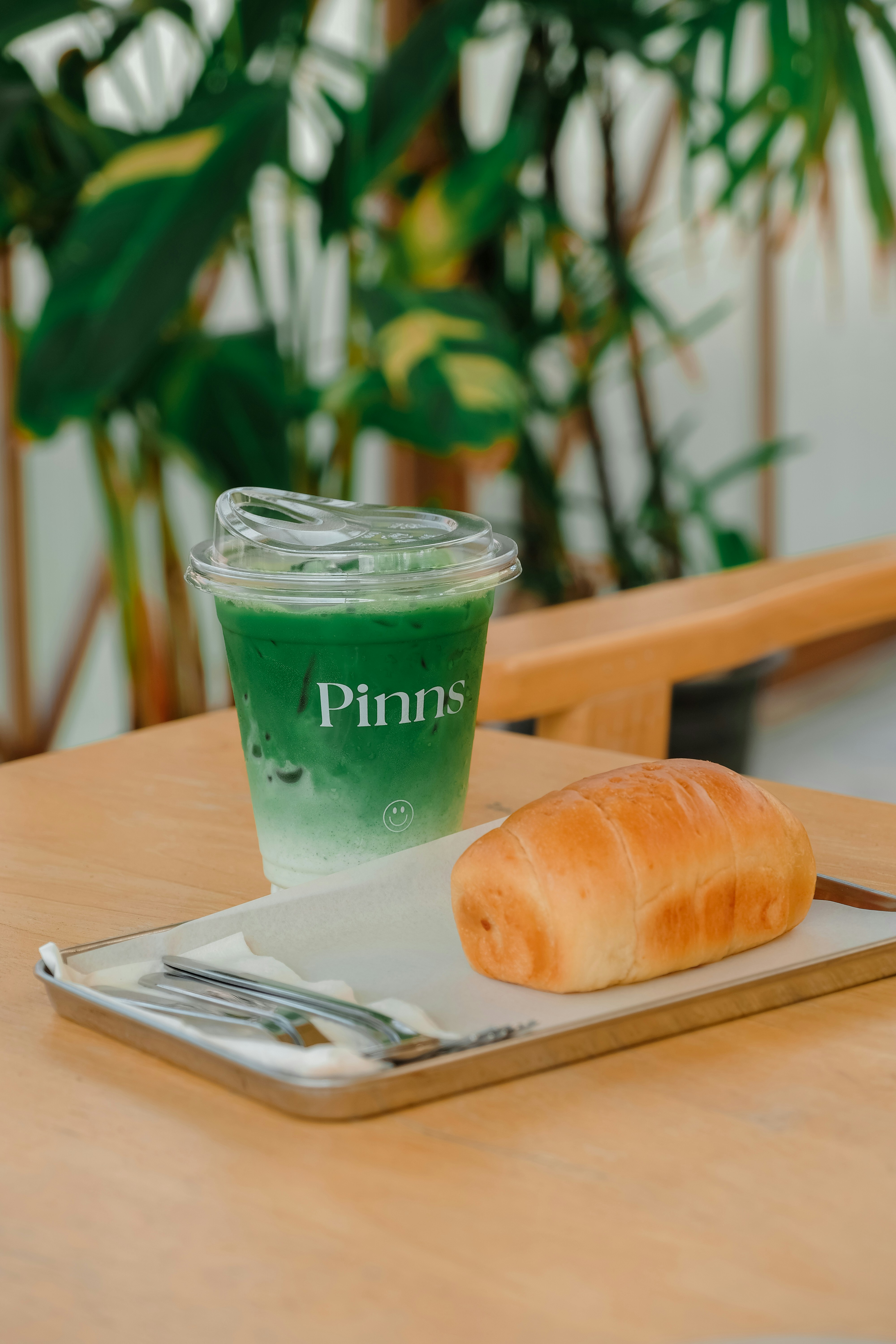 Green Iced Matcha and Fresh Bakery on a Sunny Café Table