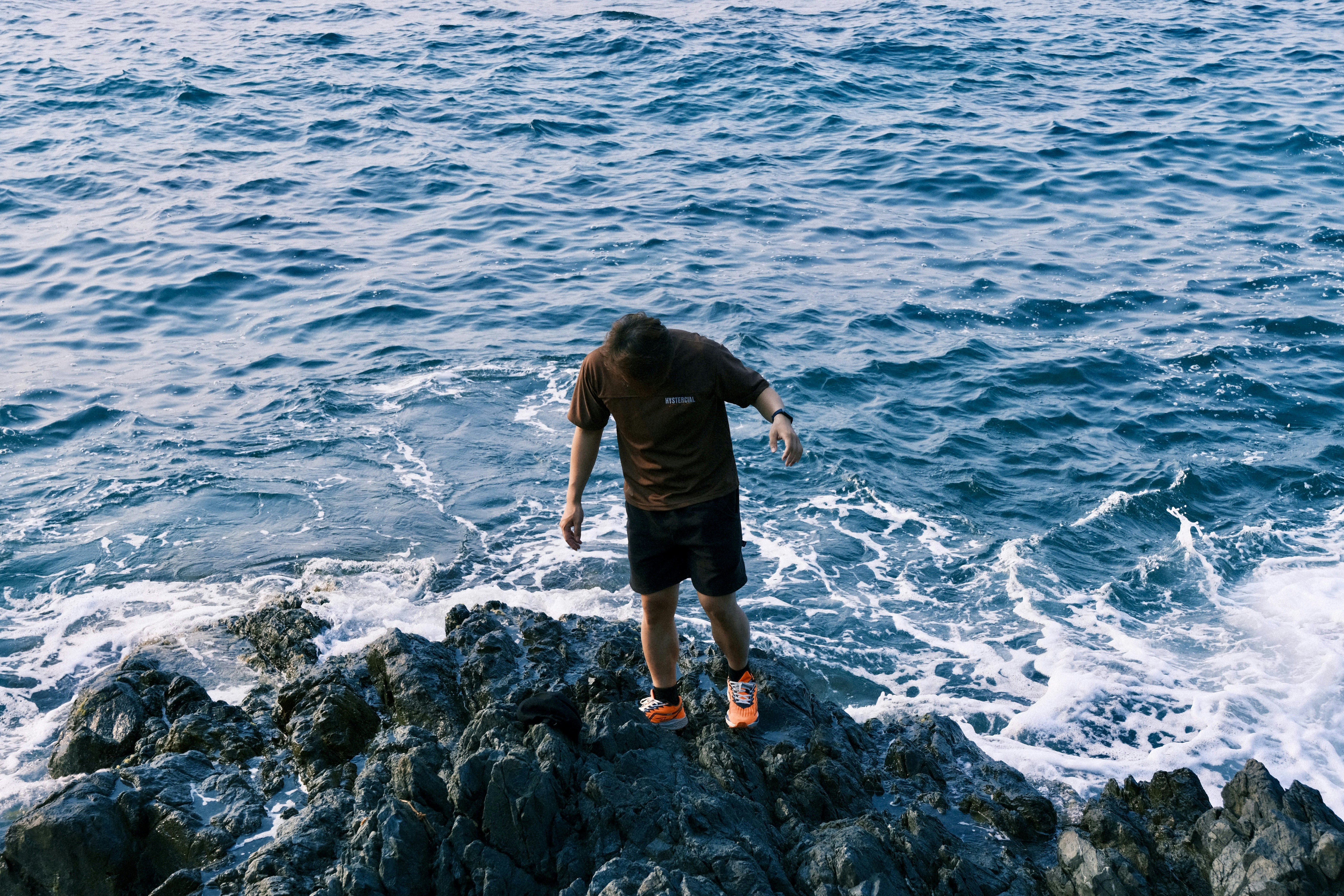 Edgewalker on basalt: a lone climber braves the sea's edge