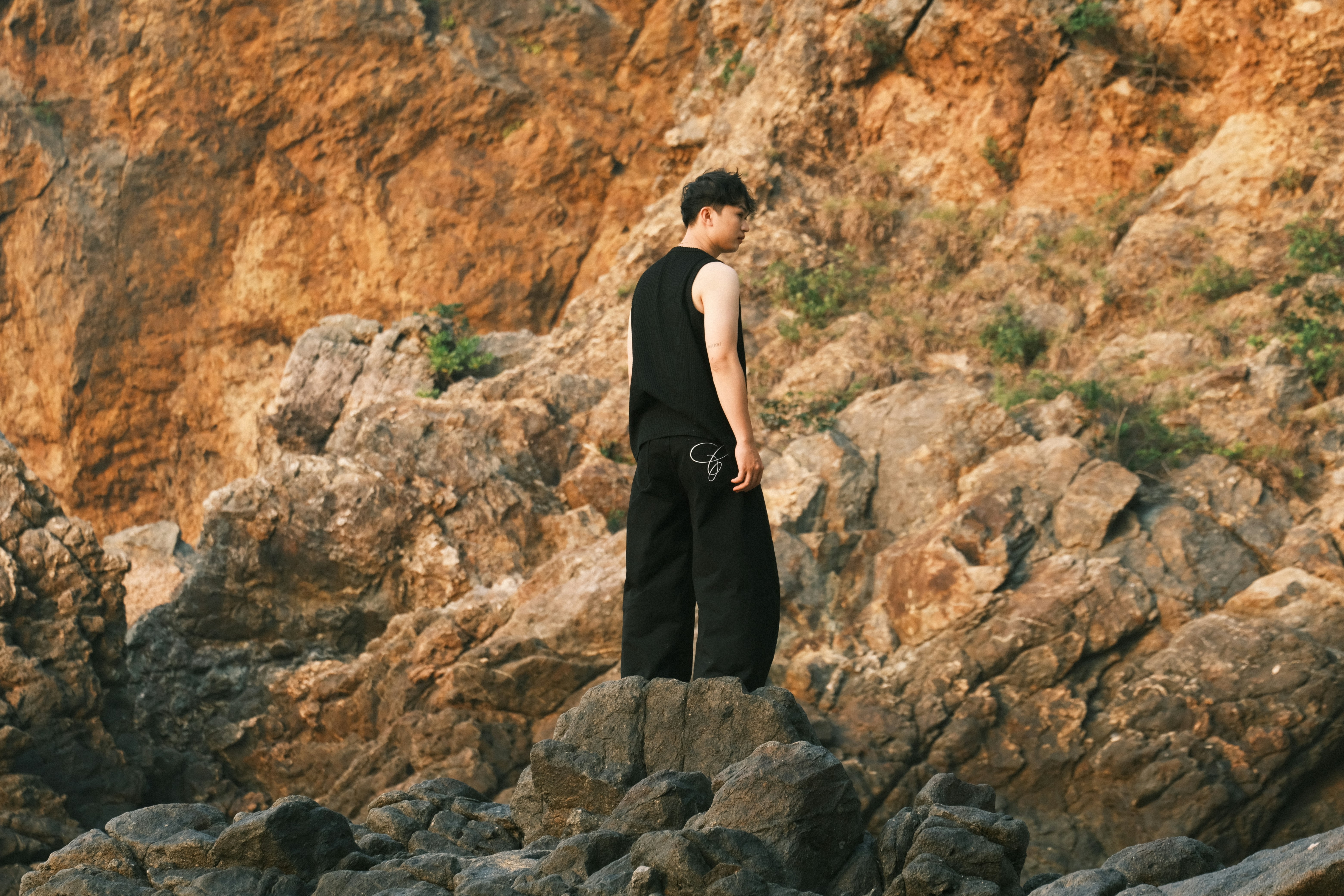 Lone Figure Standing Amidst Weathered Cliffs