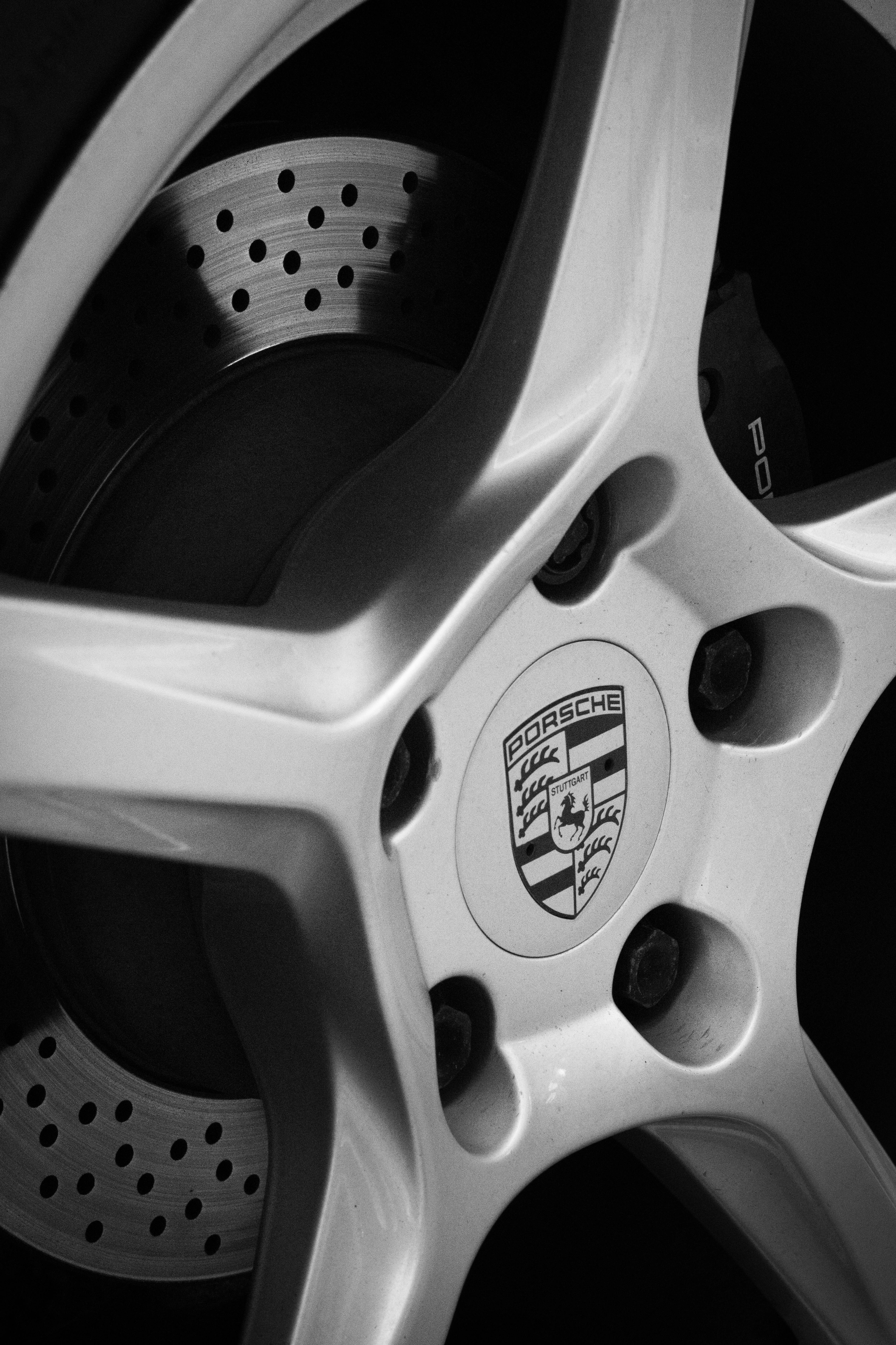 Porsche Crest in Focus: Close-Up of a Wheel Rim and Brake Detail