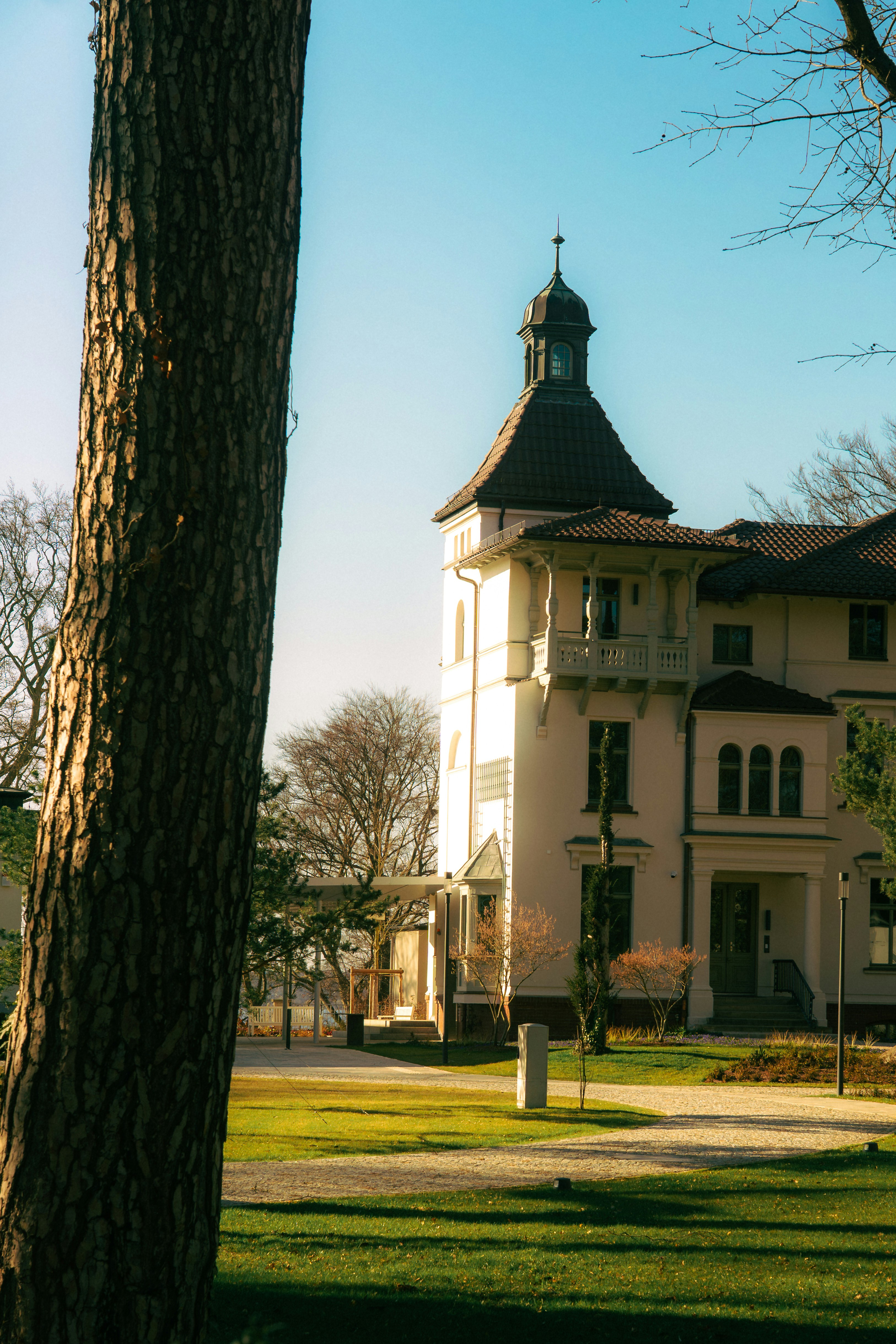 Elegant turreted mansion rises from a sunlit park