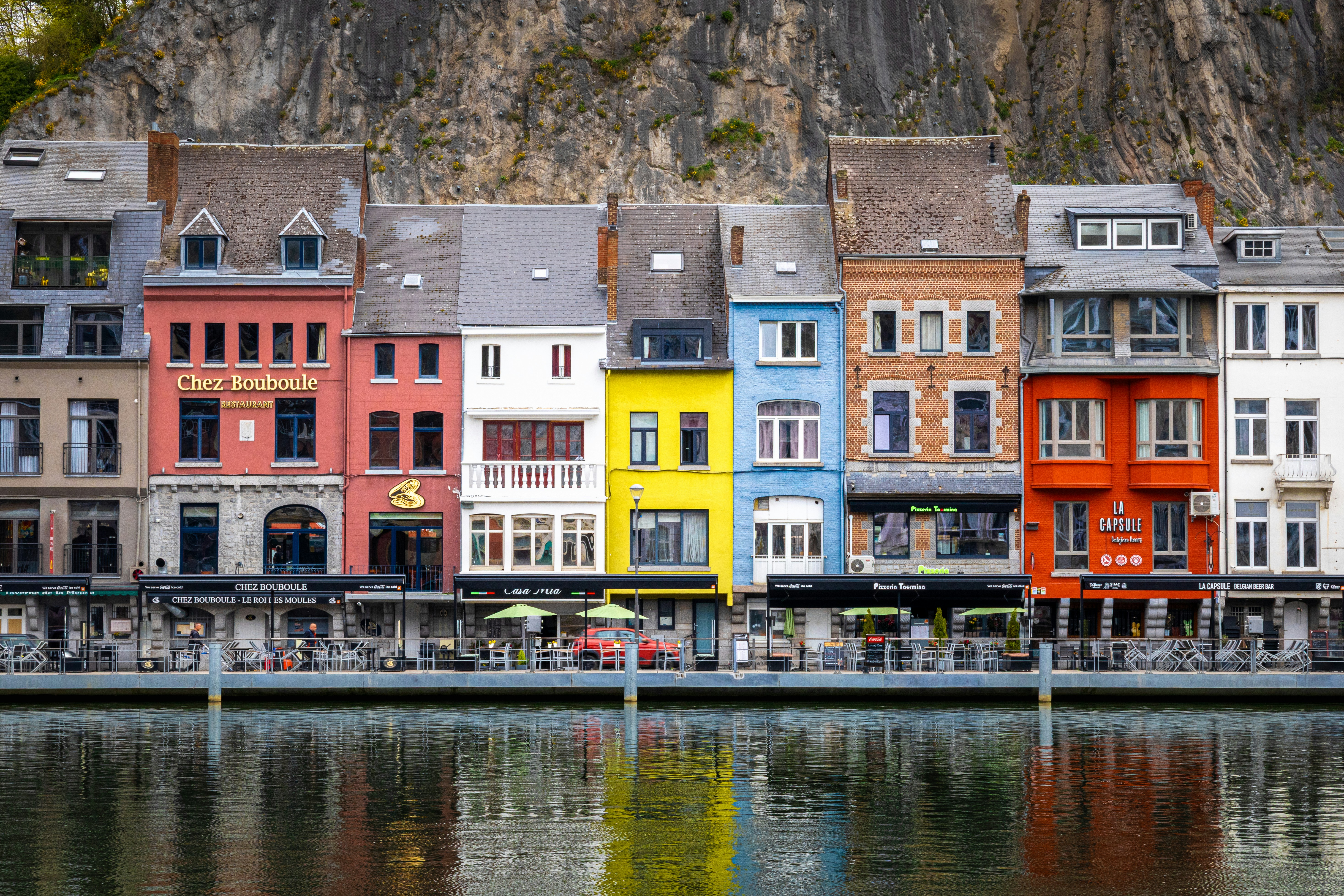 Colorful riverside row: a row of vibrant houses reflected on calm water