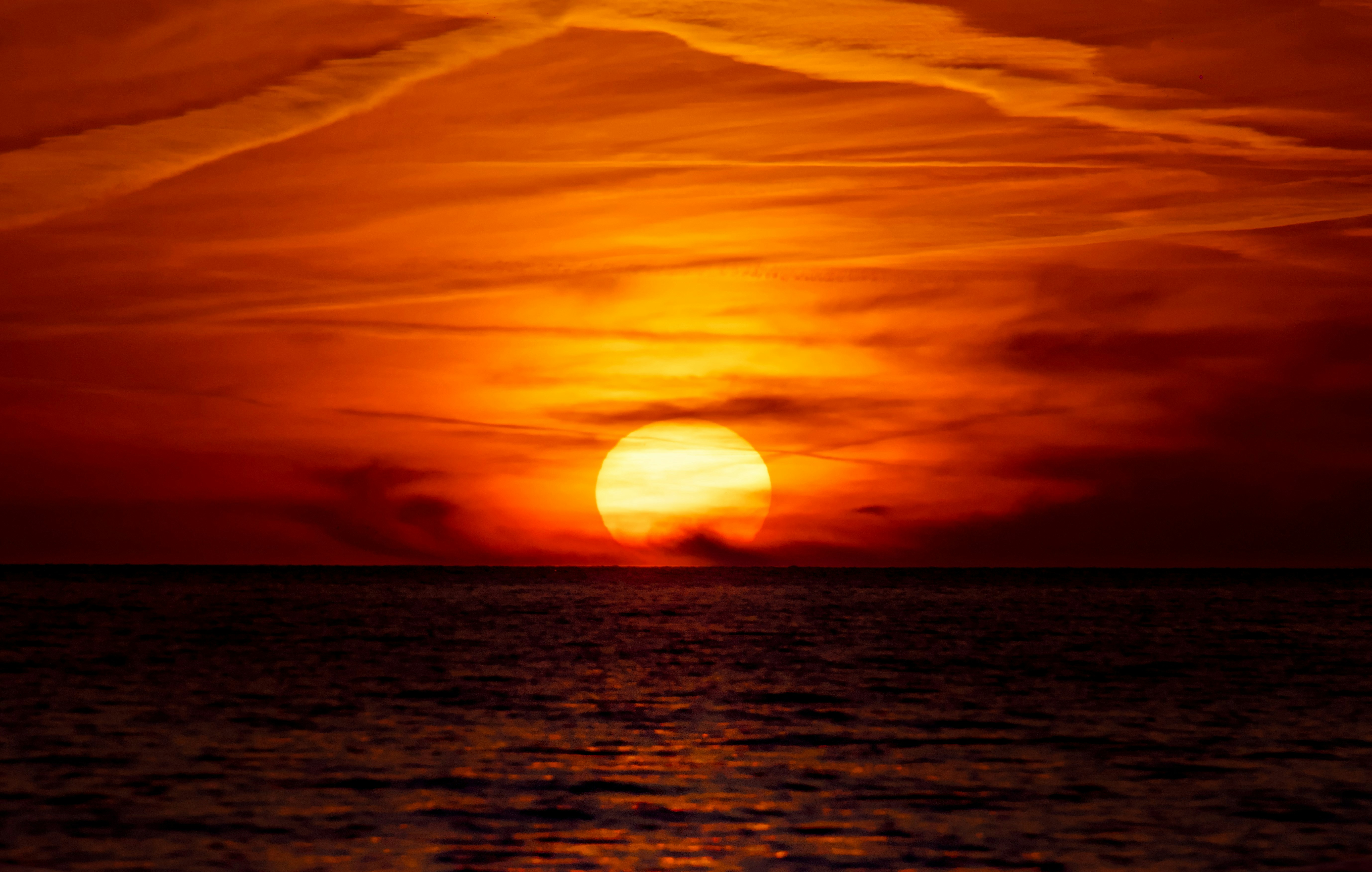 Horizon Ember: A Fiery Sunset over Quiet Seas