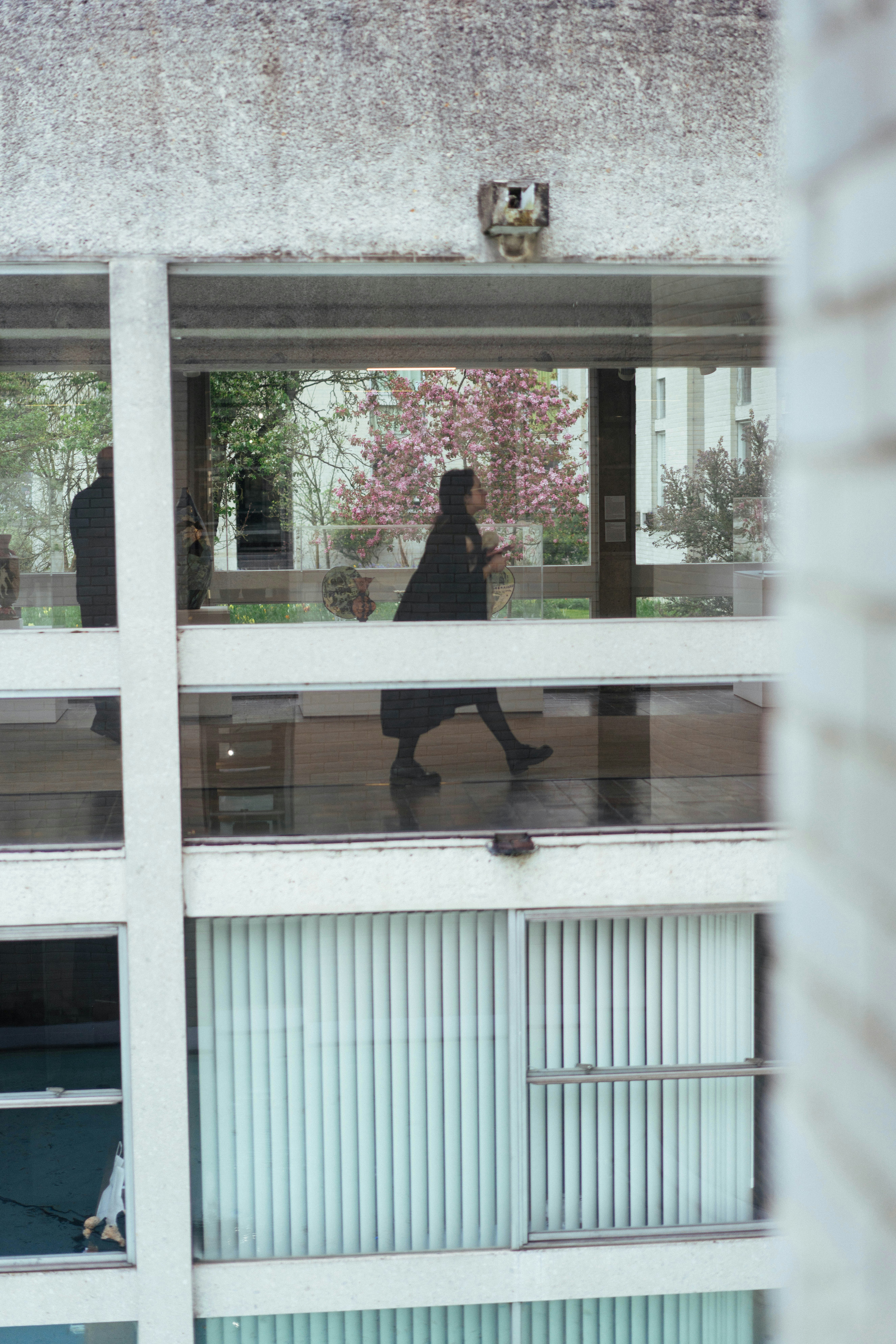 Passing Through Glass: A Silhouette in Motion