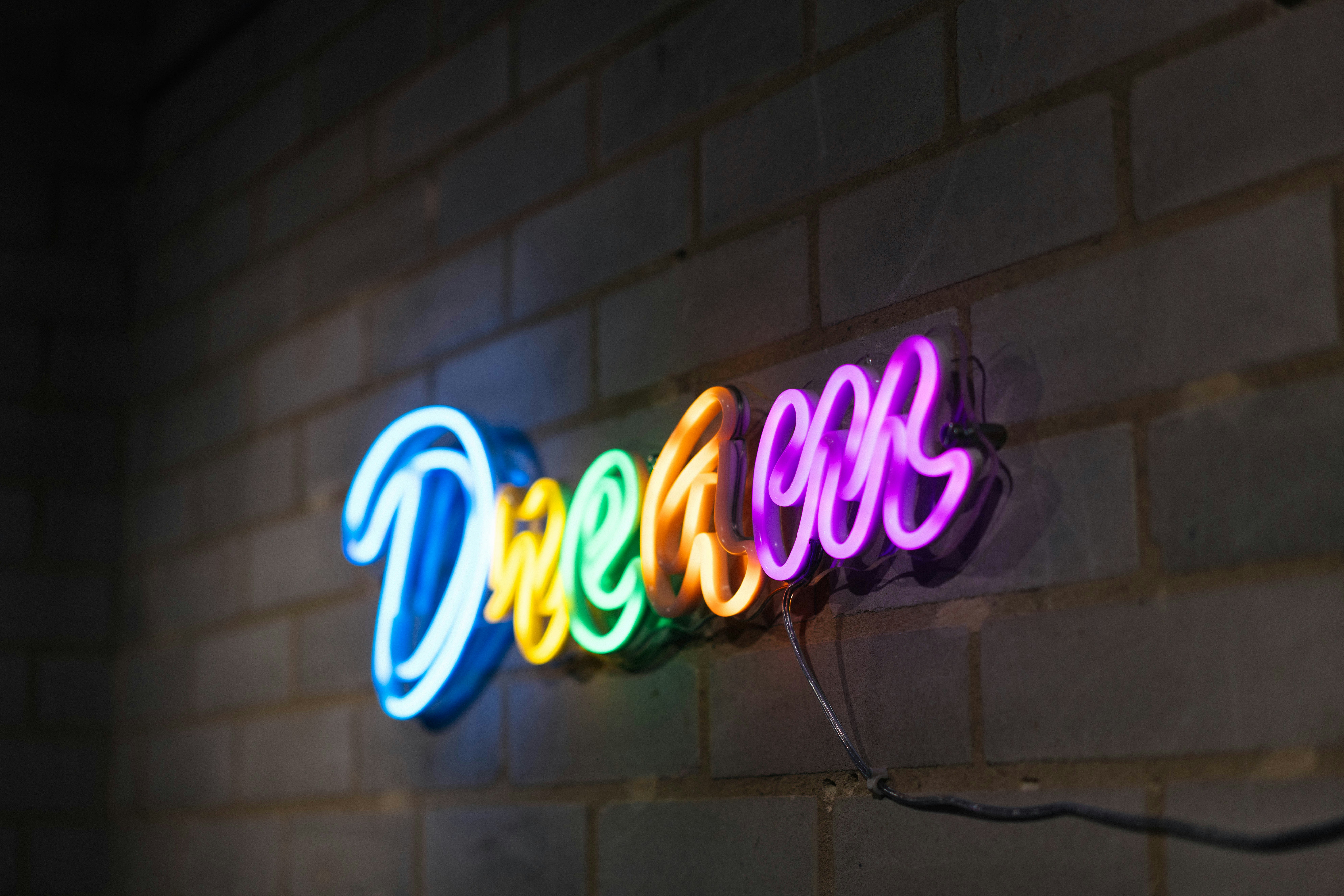 Neon Script on Brick: a Multicolor Glow in the Industrial Wall