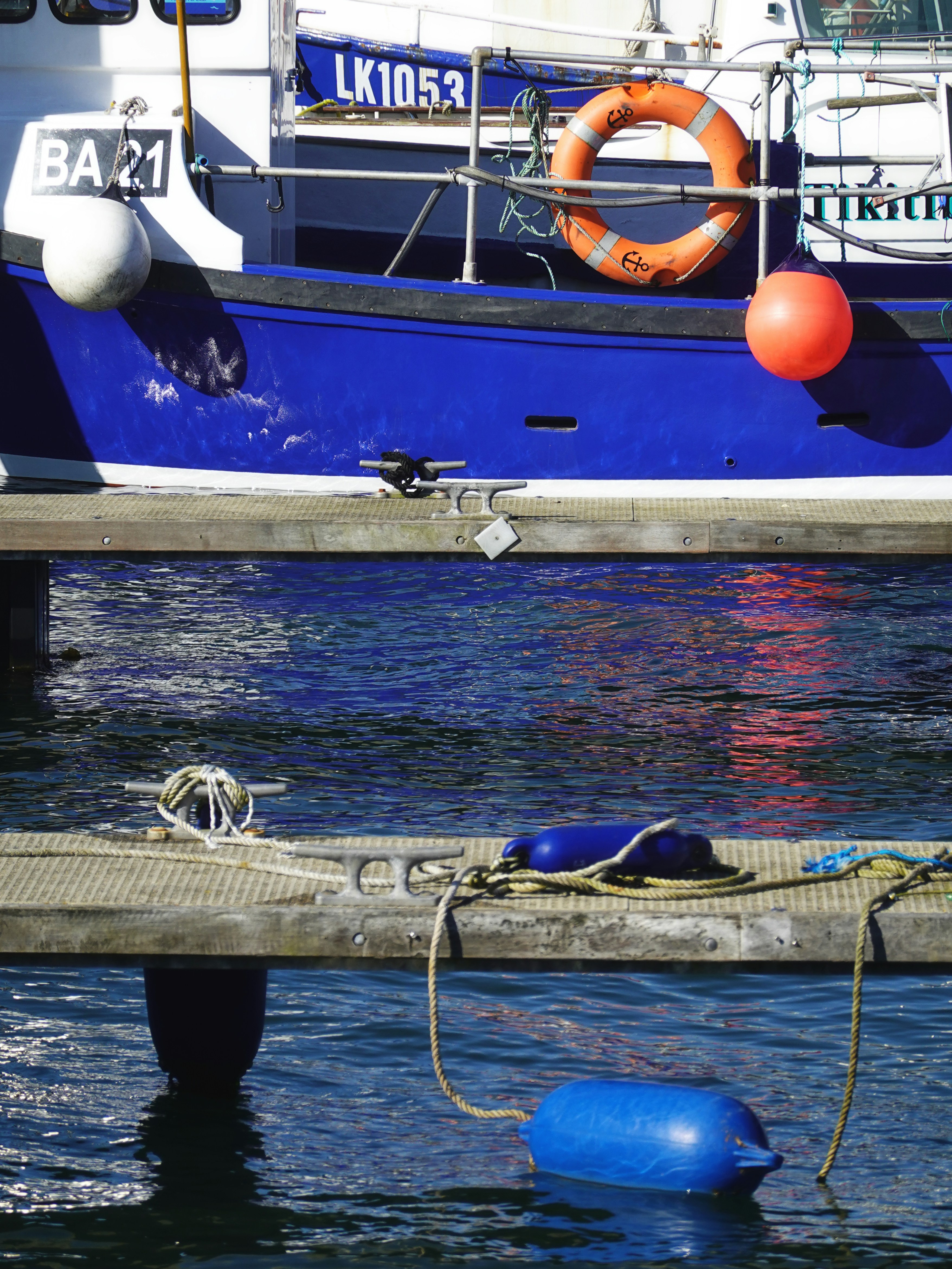 Roped Dockside: A Blue Vessel at Rest
