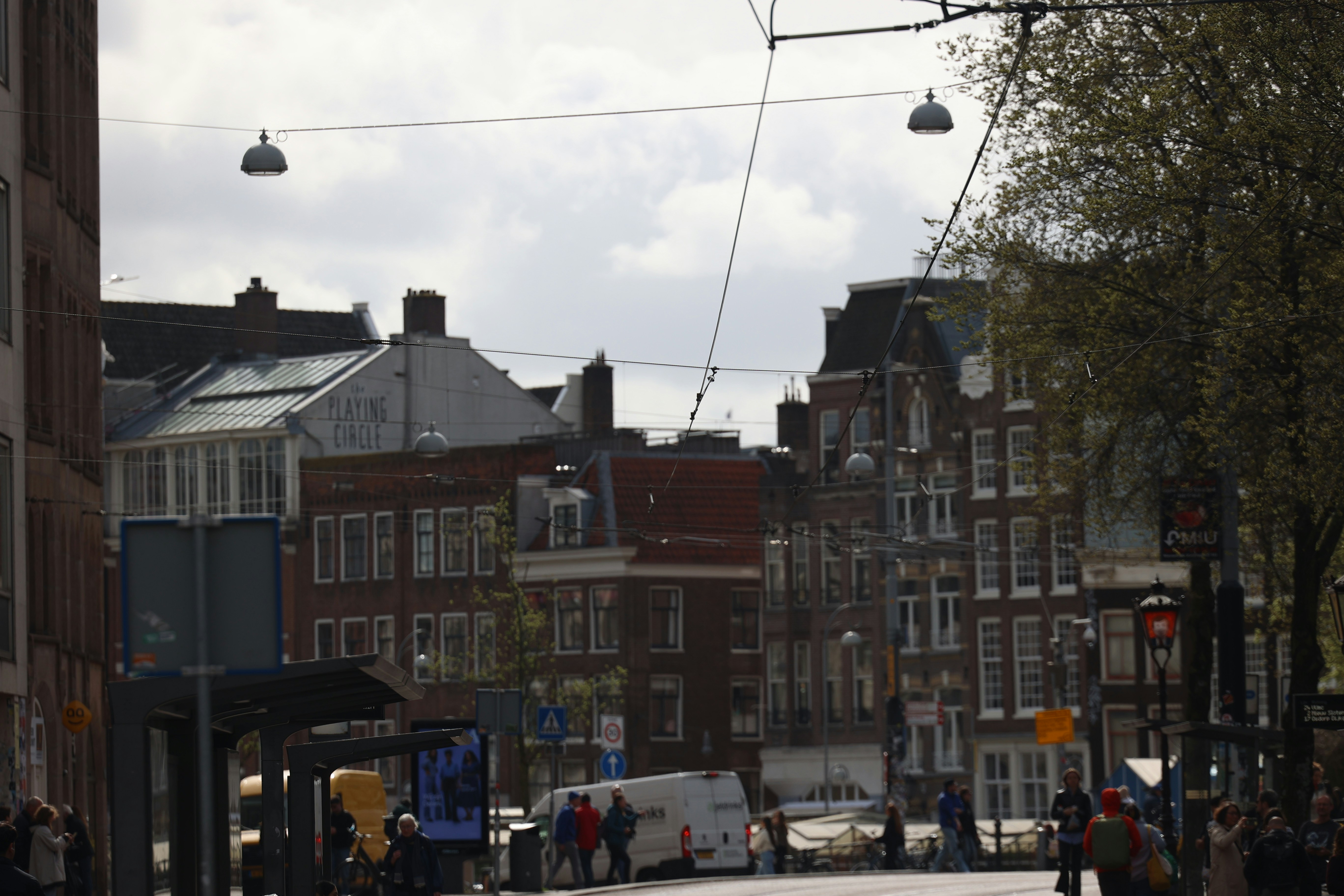 Urban Street Scene: People and Tram Lines in Quiet Dutch-Style Core