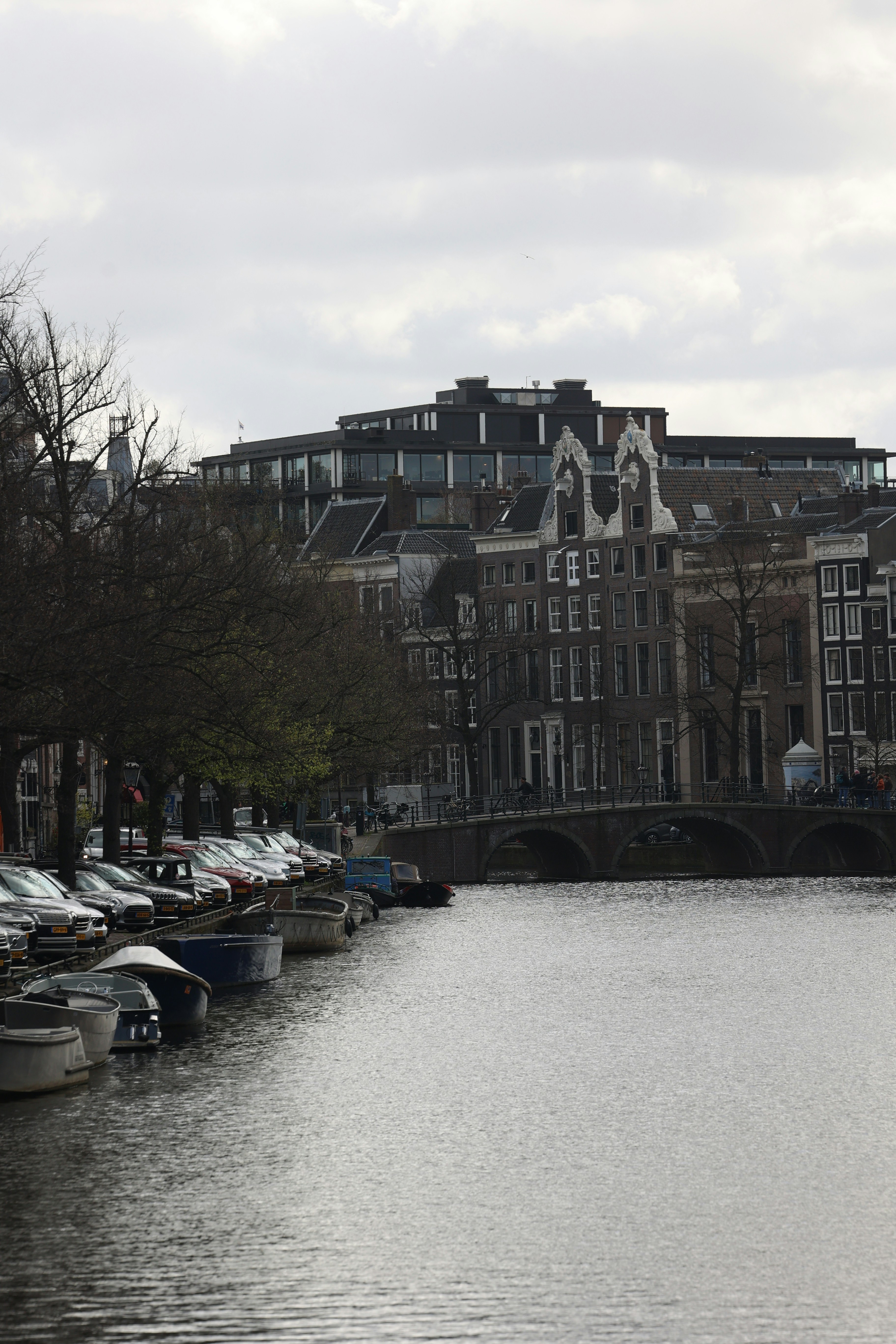 Canalfront in Amsterdam: Boats, Bridges, and Brick Facades