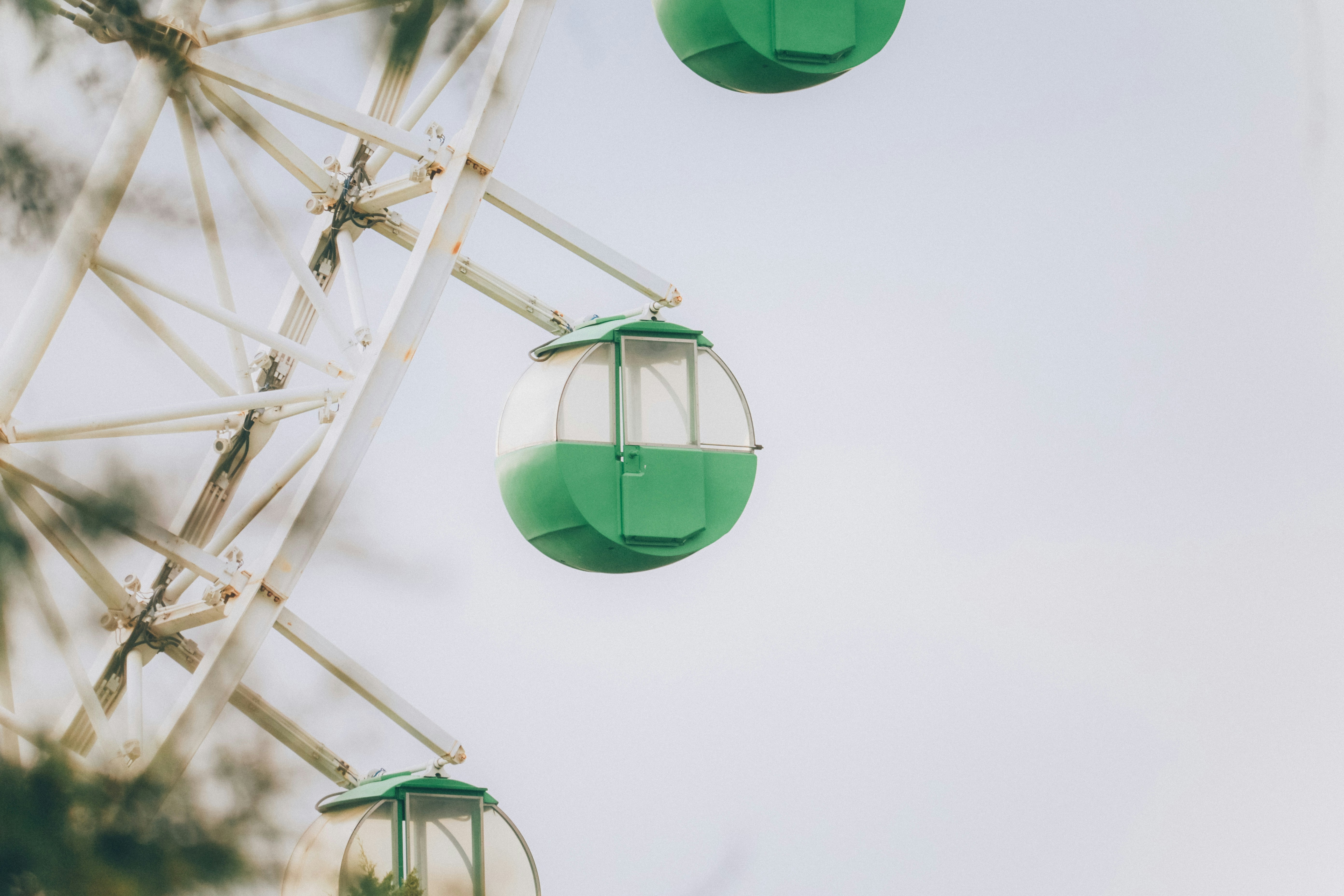 Green-Faceted Gondolas drifting over pale sky