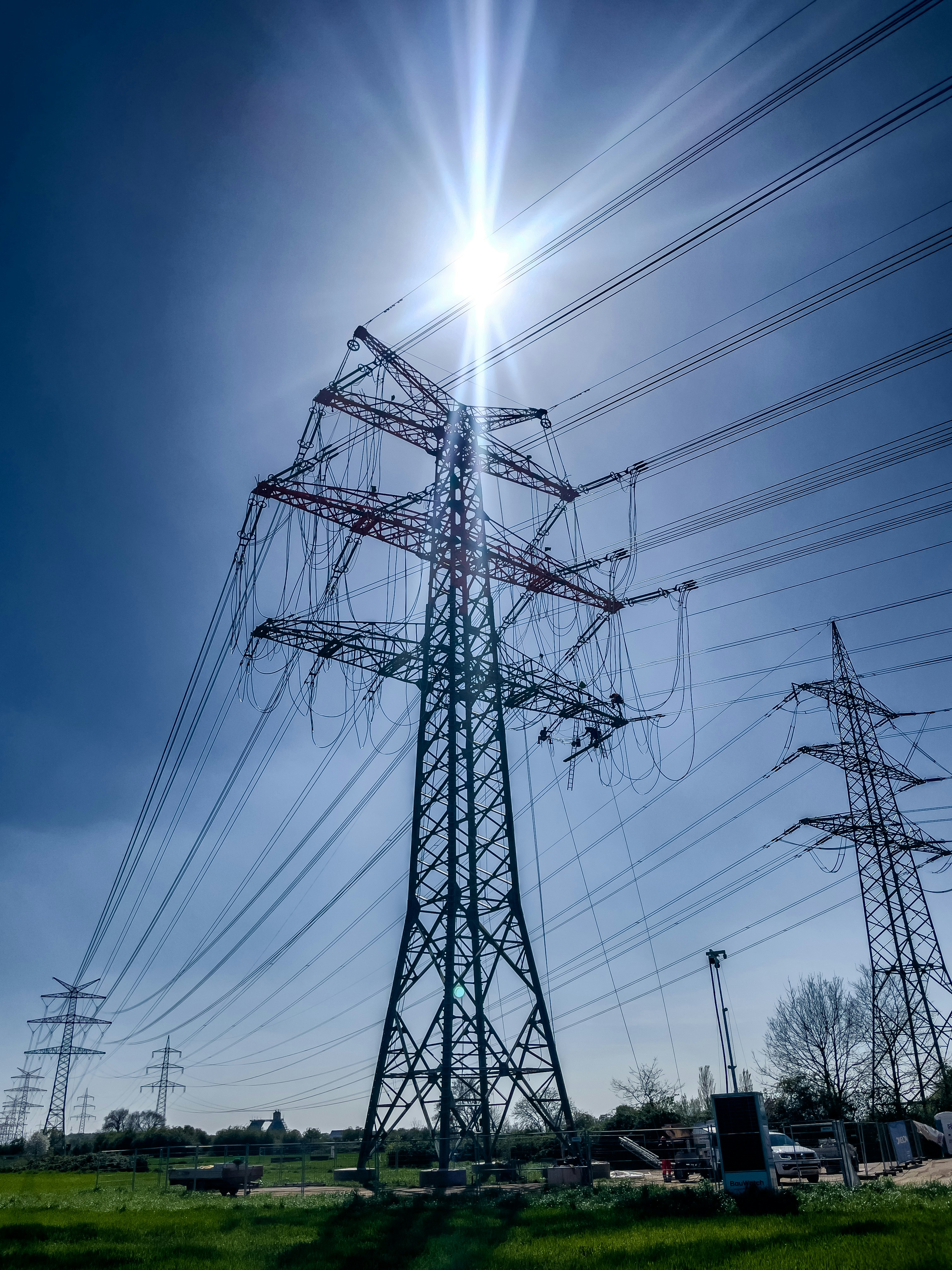 Sunlit Skyline: Power Tower Under a Glassy Sky