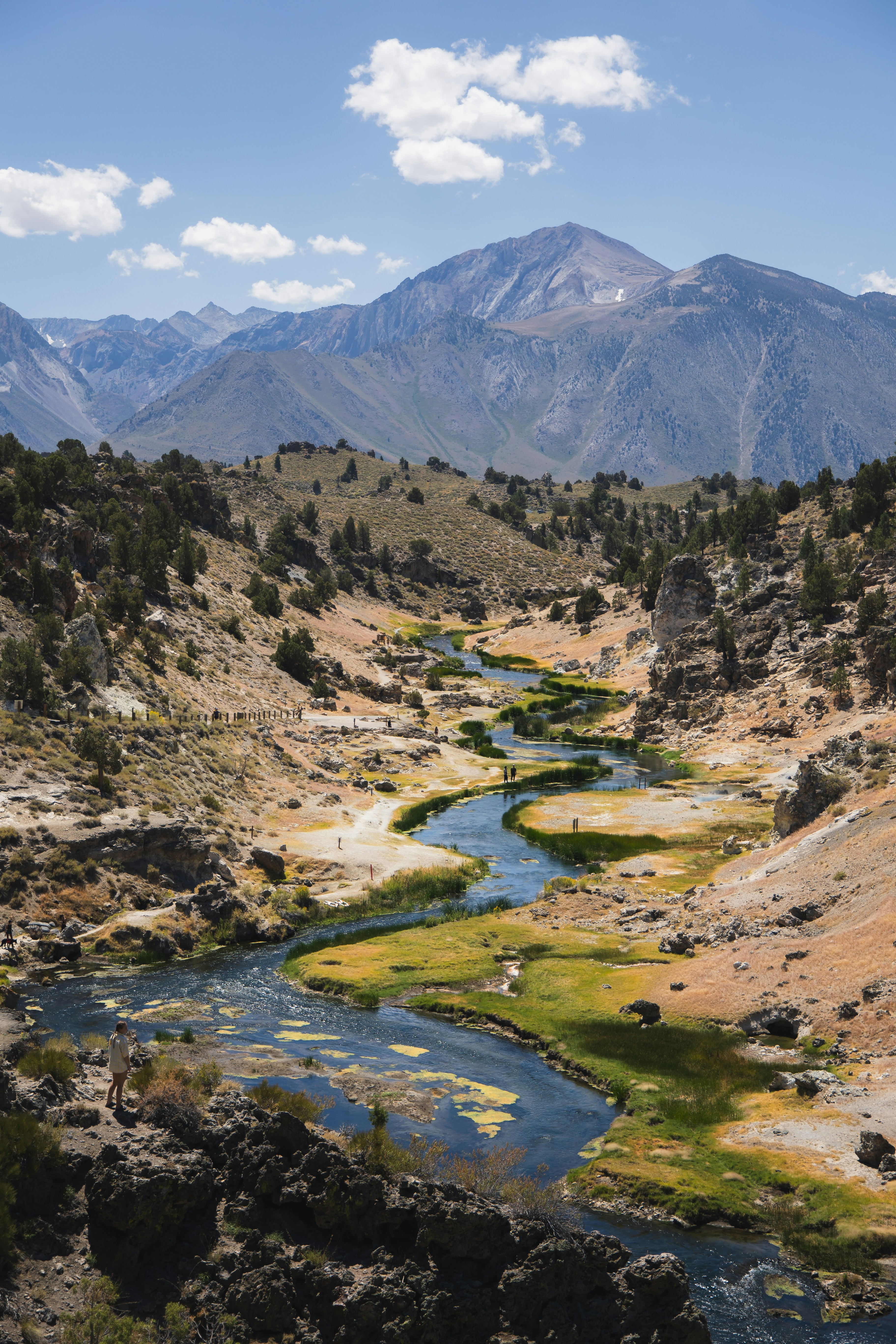 River of Color through rugged highland valley beneath a crystalline sky