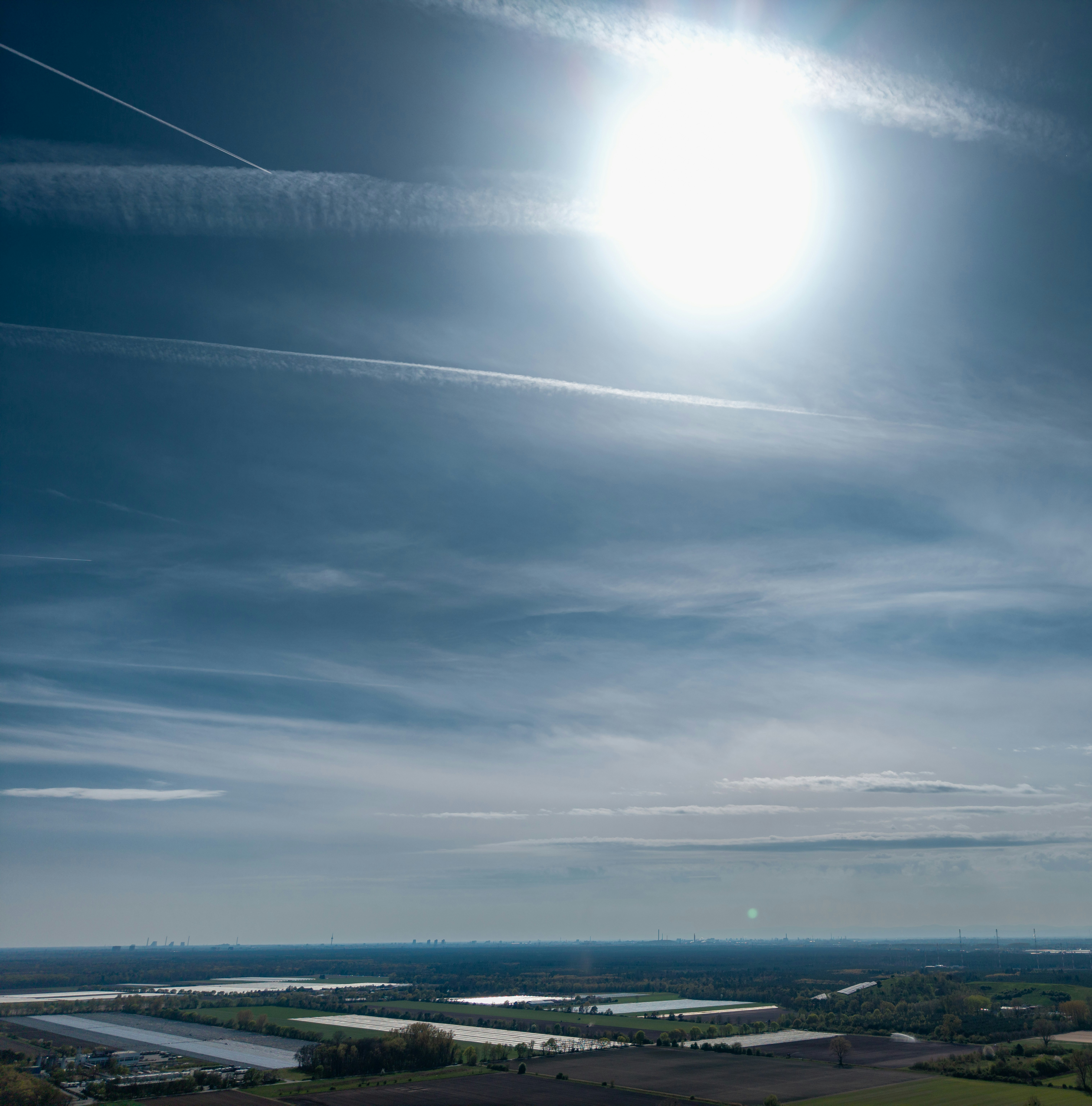 High Noon Over Flatlands: Aerial Sweep Across Sunlit Fields