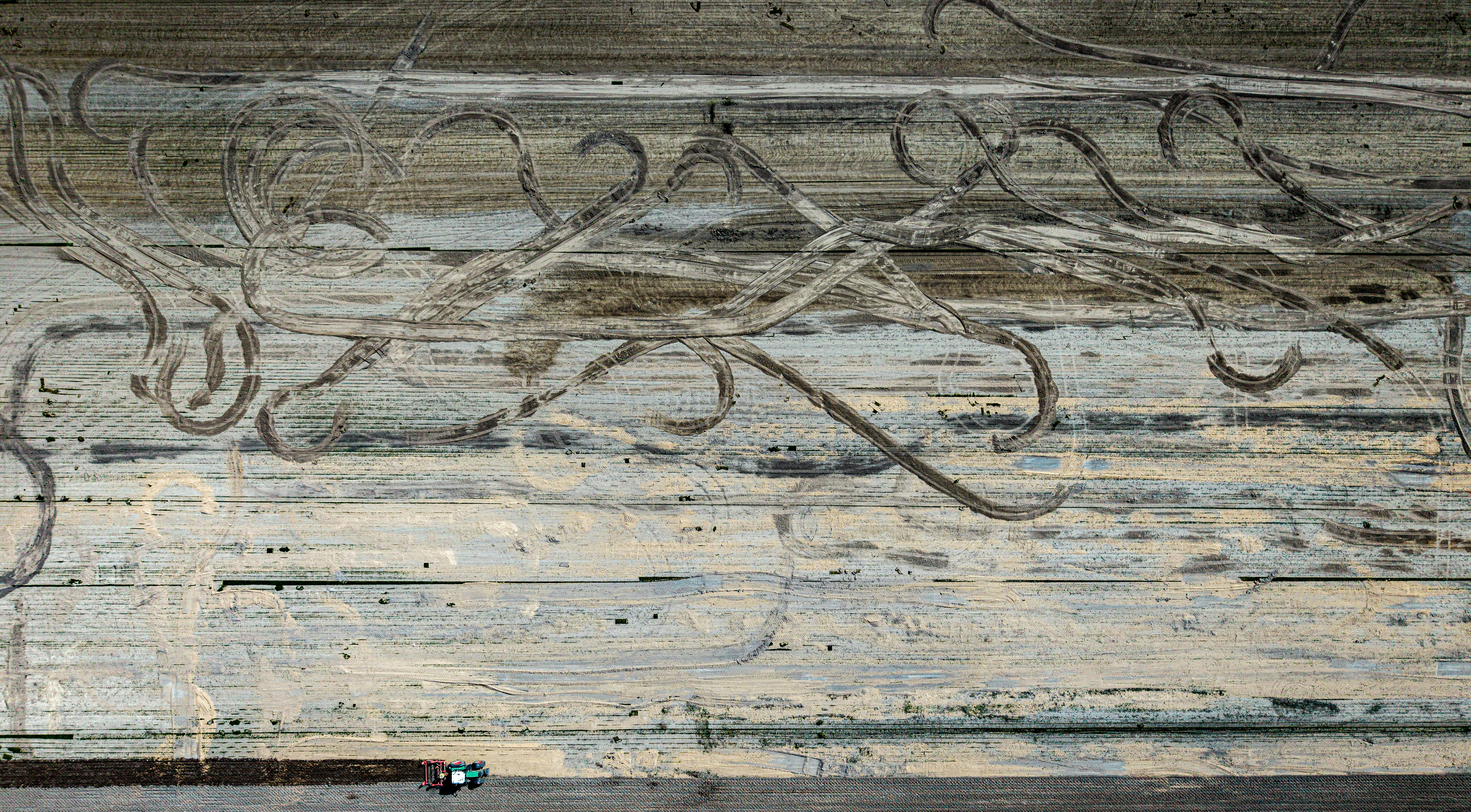 Rusted Ribbons: Drone View of Weathered Dock and Tangled Cables