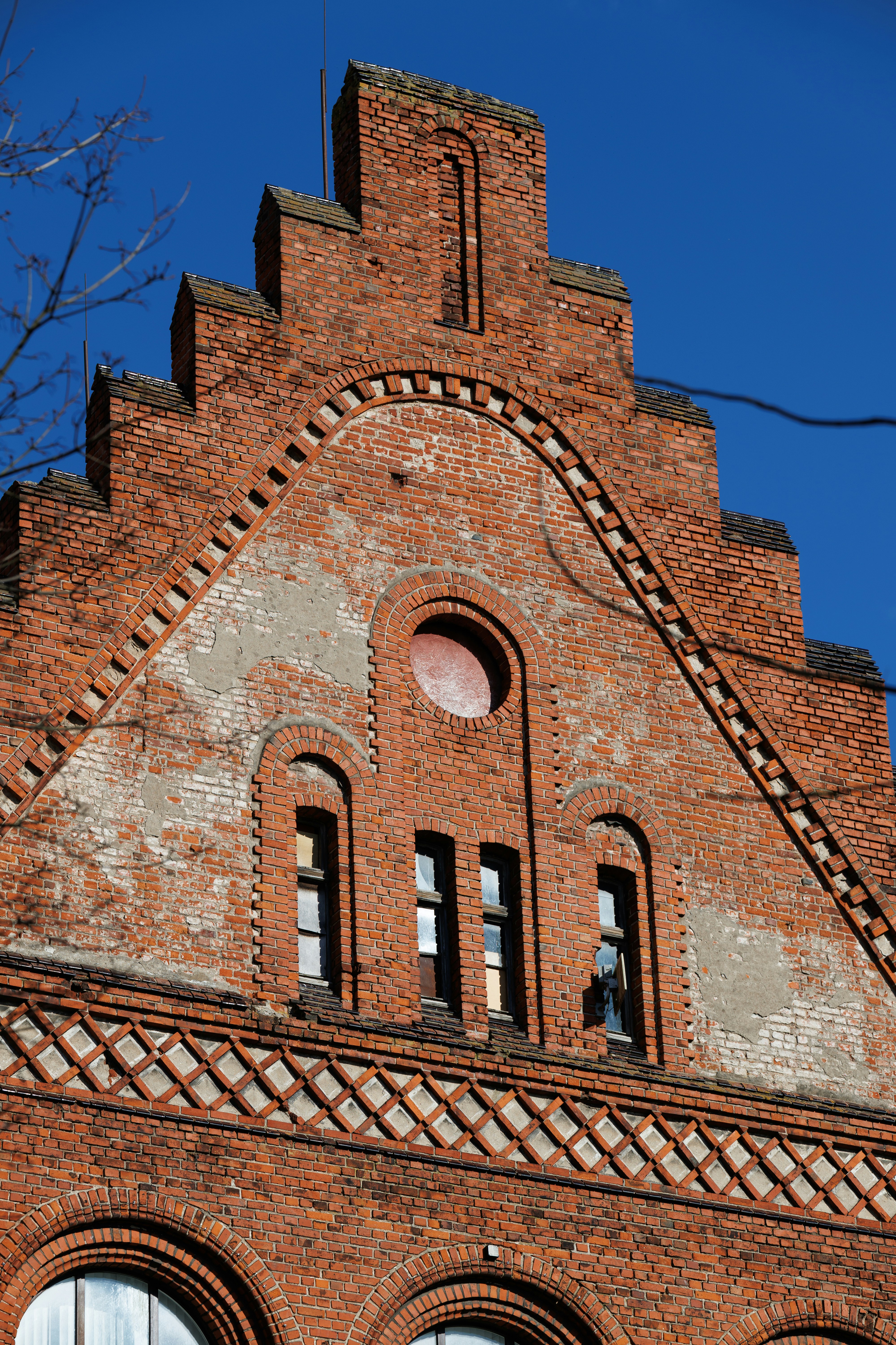 Brick Facade Ascendancy: A stepped gable under a cobalt sky
