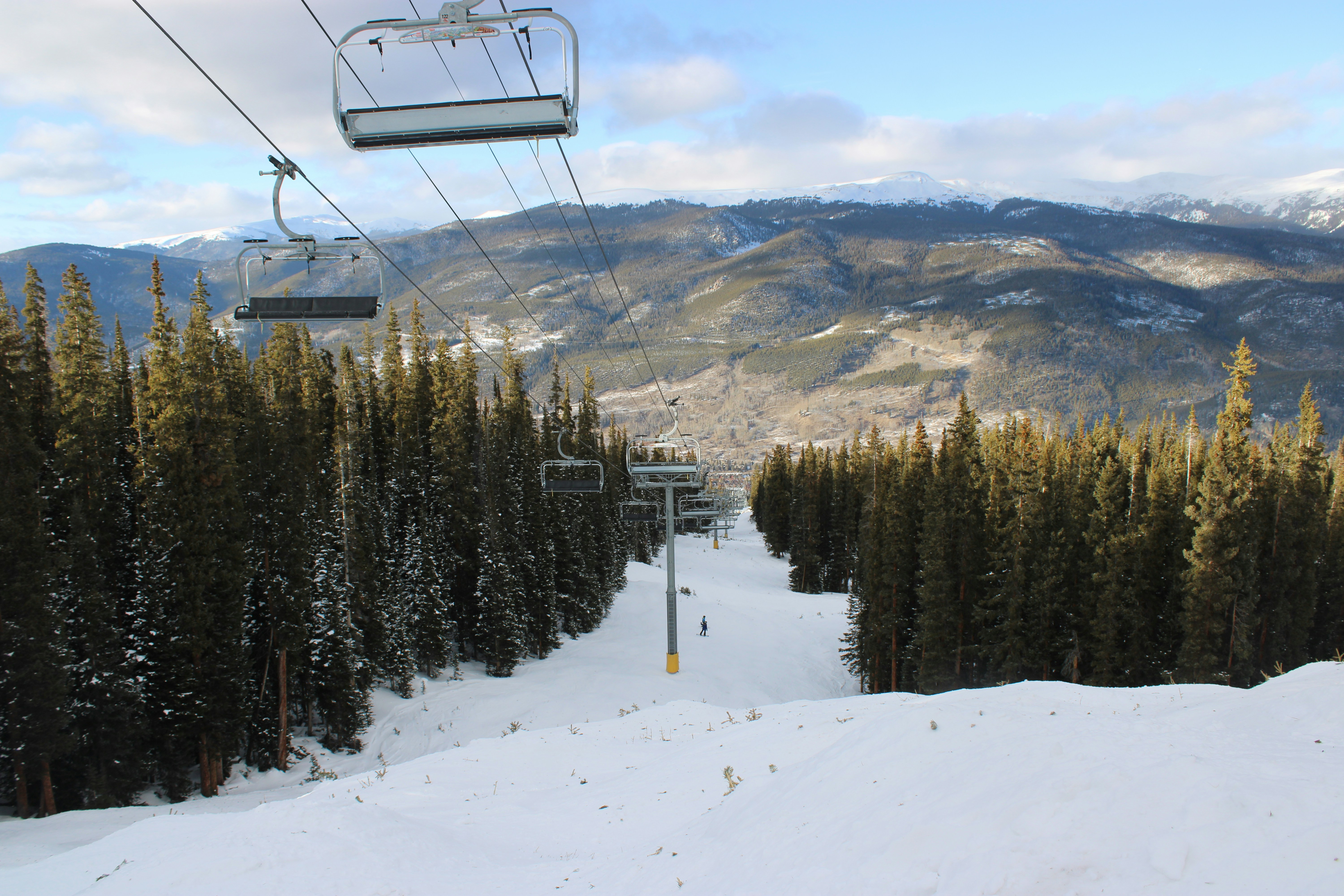 Lift toward the Pines: Snow-Capped Spine of the Mountain Valley