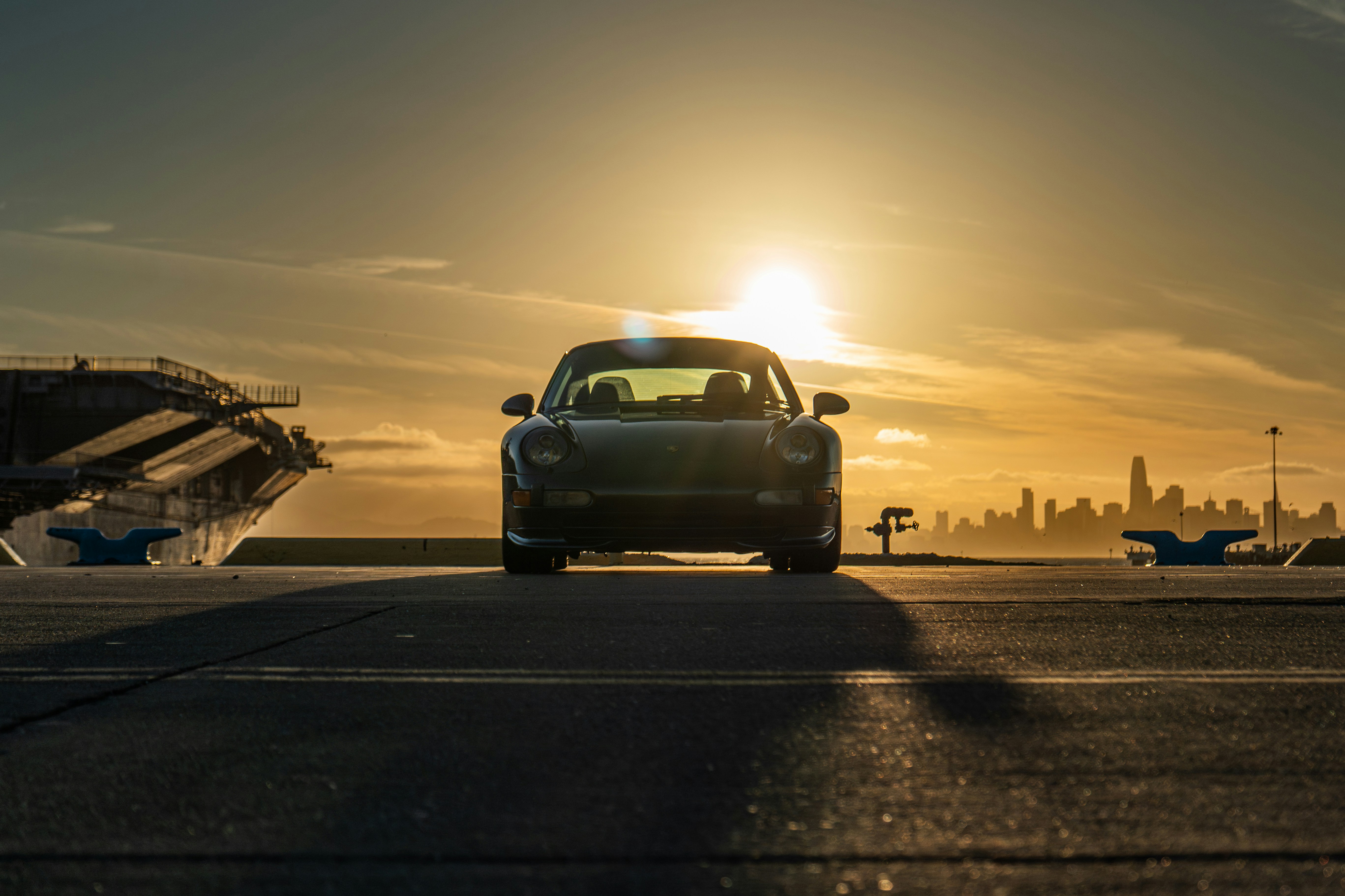 Sunlit Charger: A Low-Cangle Stare at a Sports Car on a Pier at Dusk