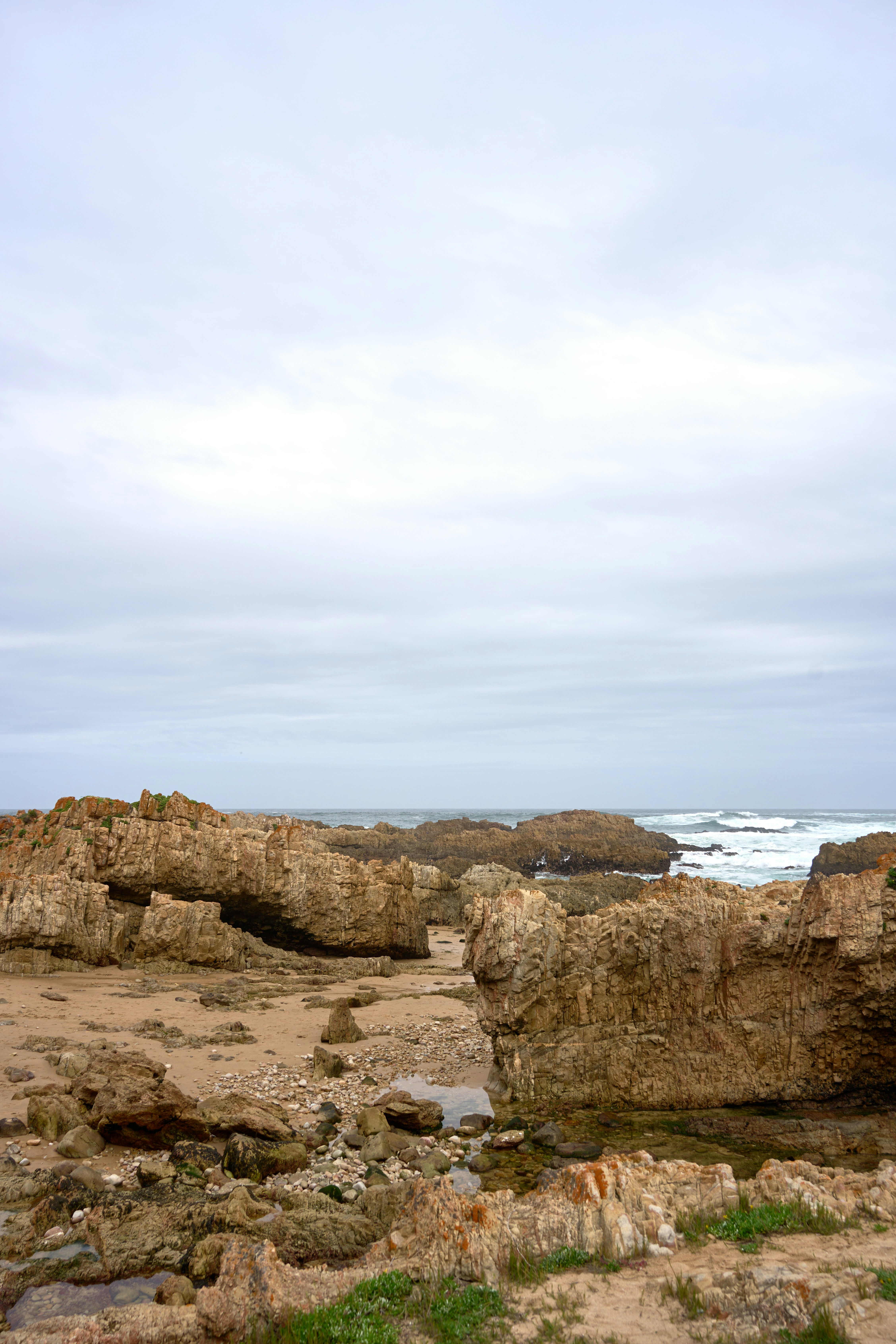 Rocky Shoreline Span Under Quiet Skies