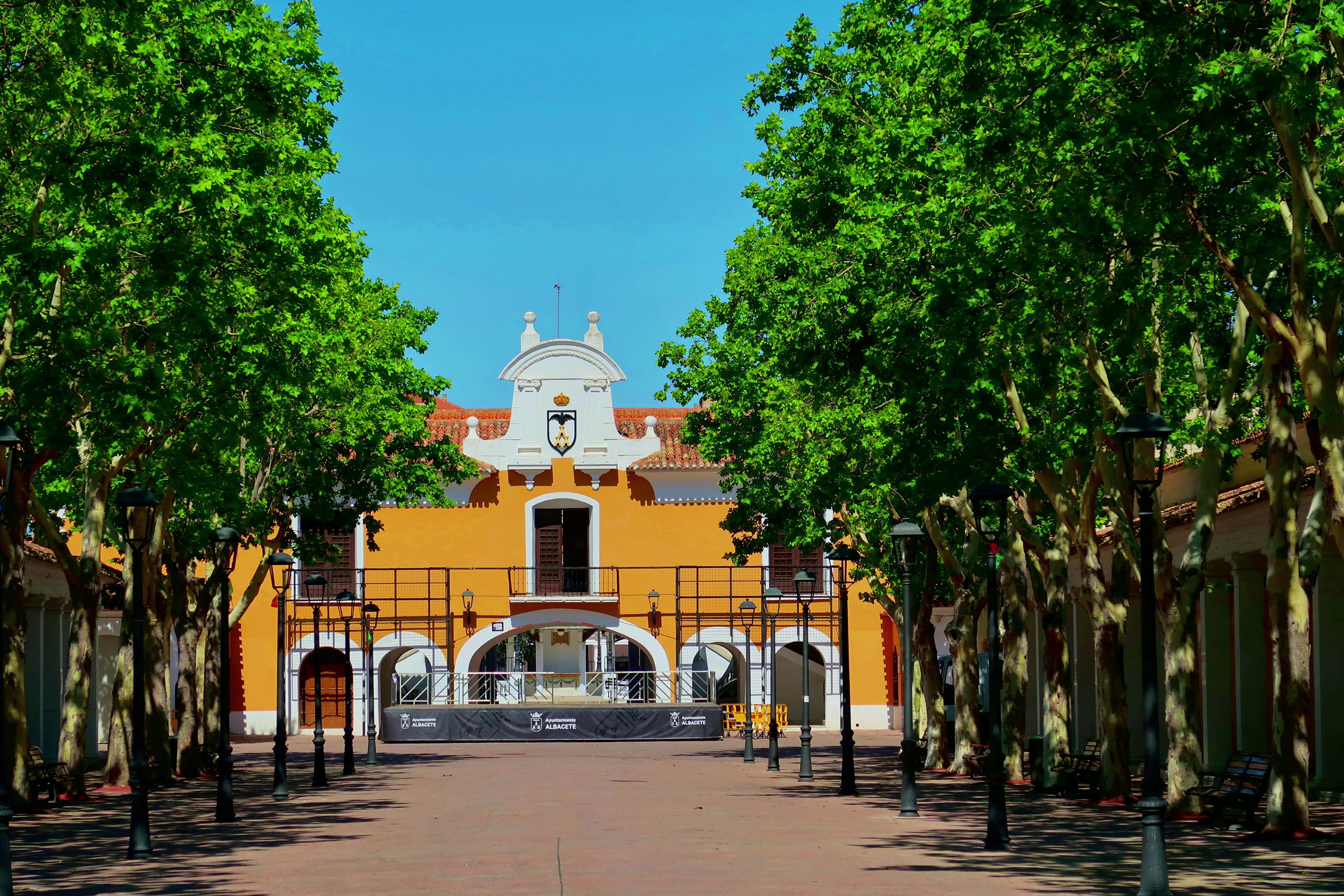 City Gate Aflame with Citrus-Orange Facade and Tree-Lined Approach