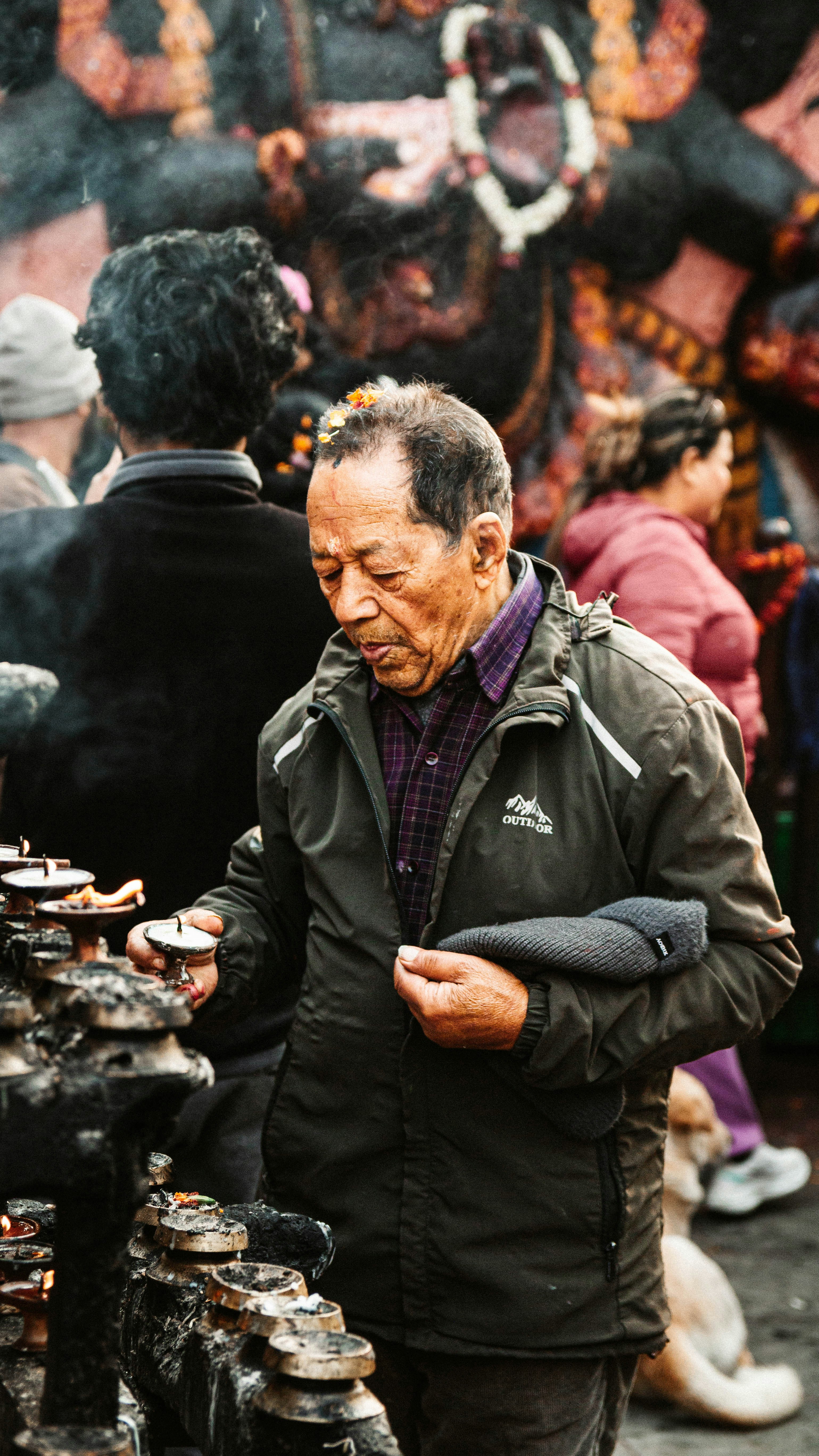 Warmth at the Shrine: An Elder Man in a Crowded Market