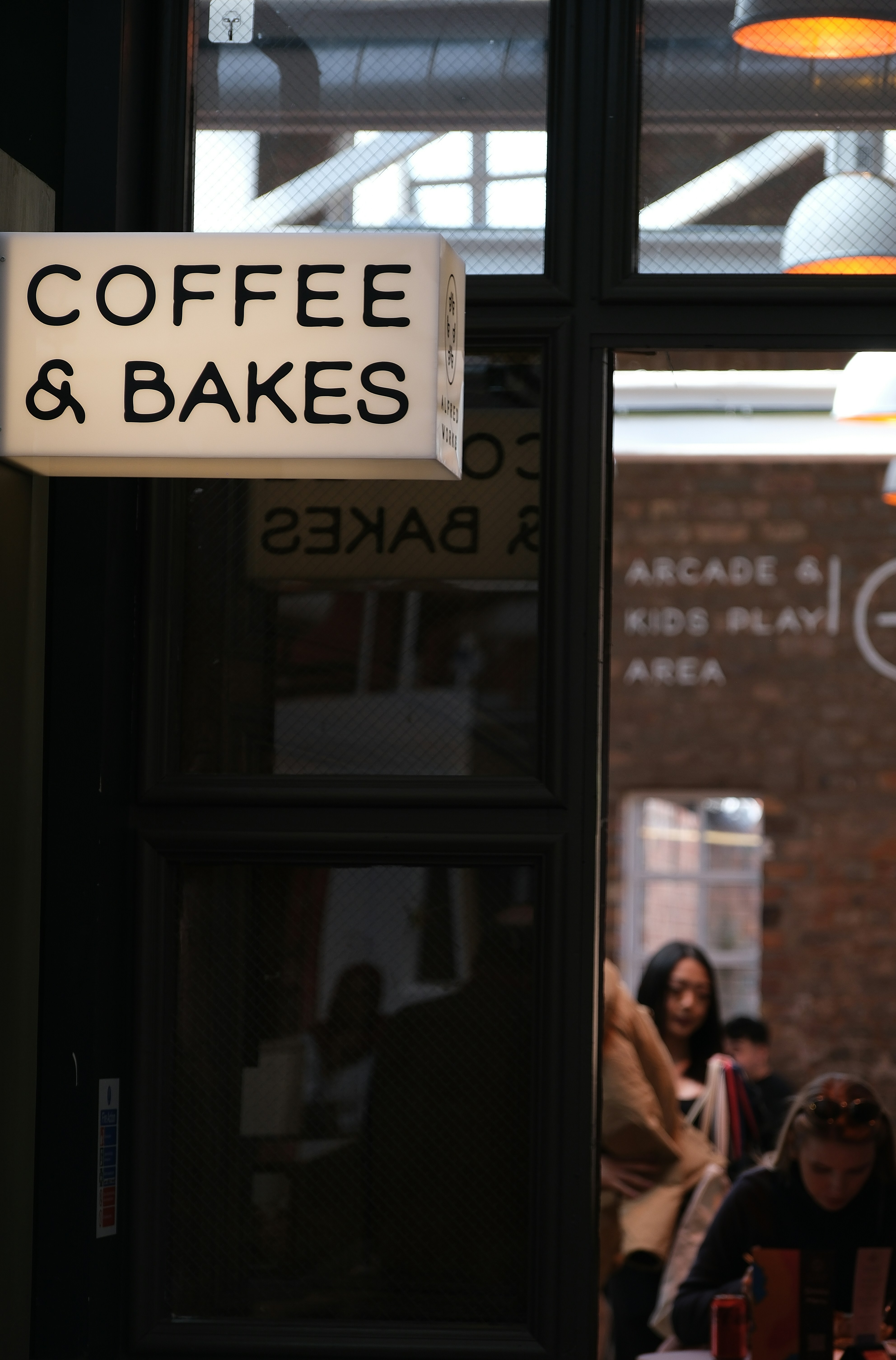 Coffee Sign at a Busy Café Entrance