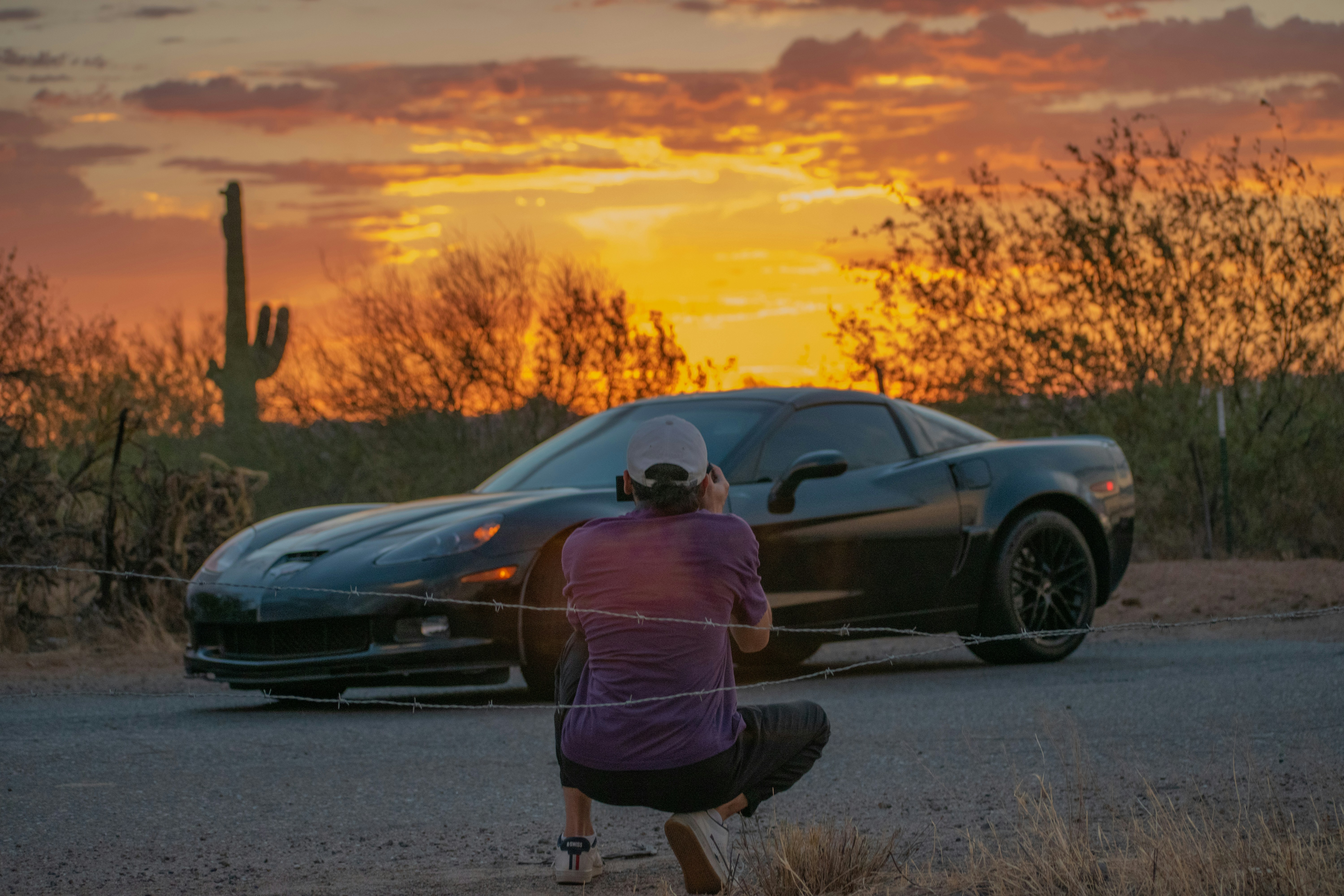 Portrait on the Road: Filmmaker in Action with a Shadowy Supercar