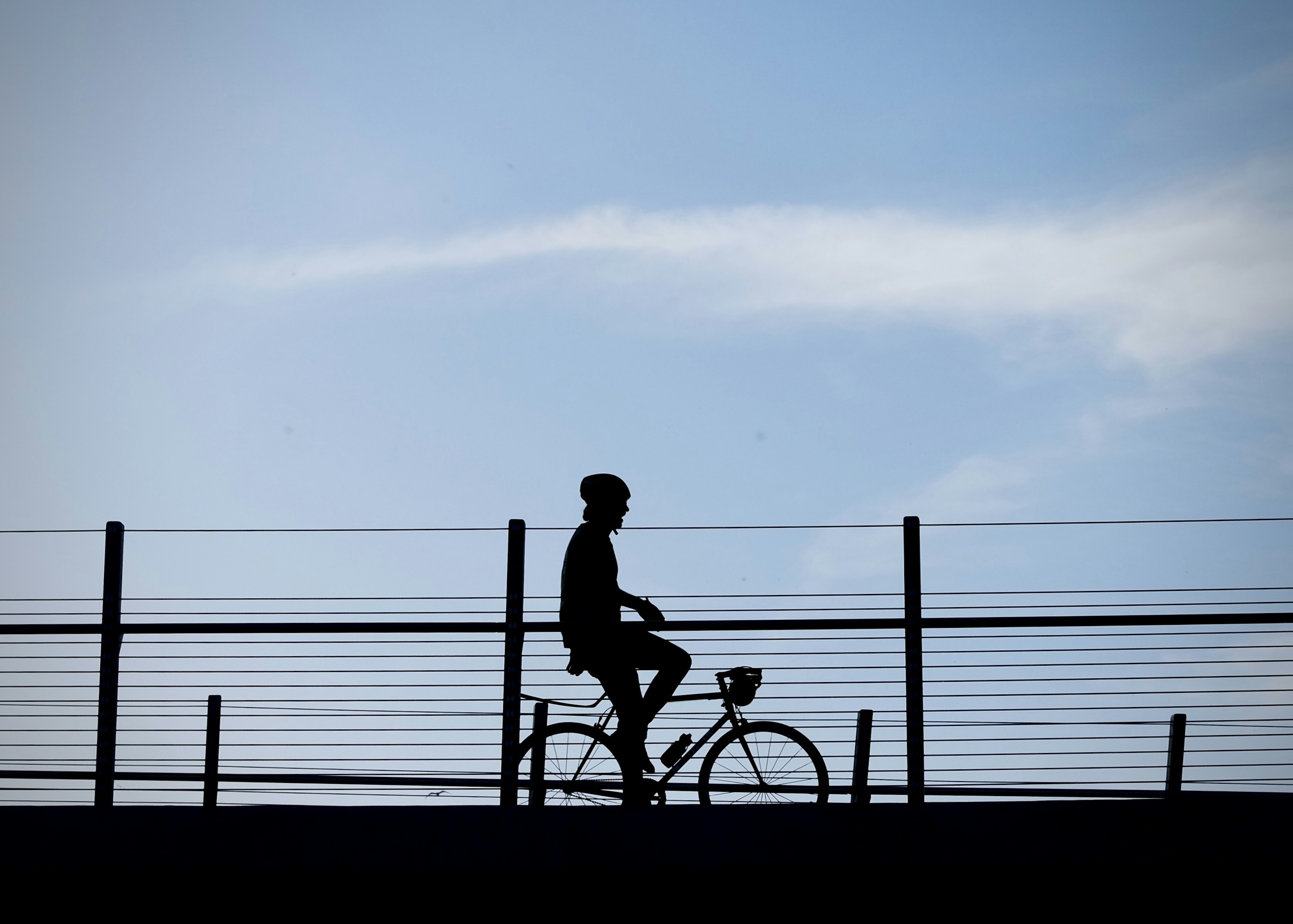 Silhouette Rider: A Quiet Moment on a Bridge