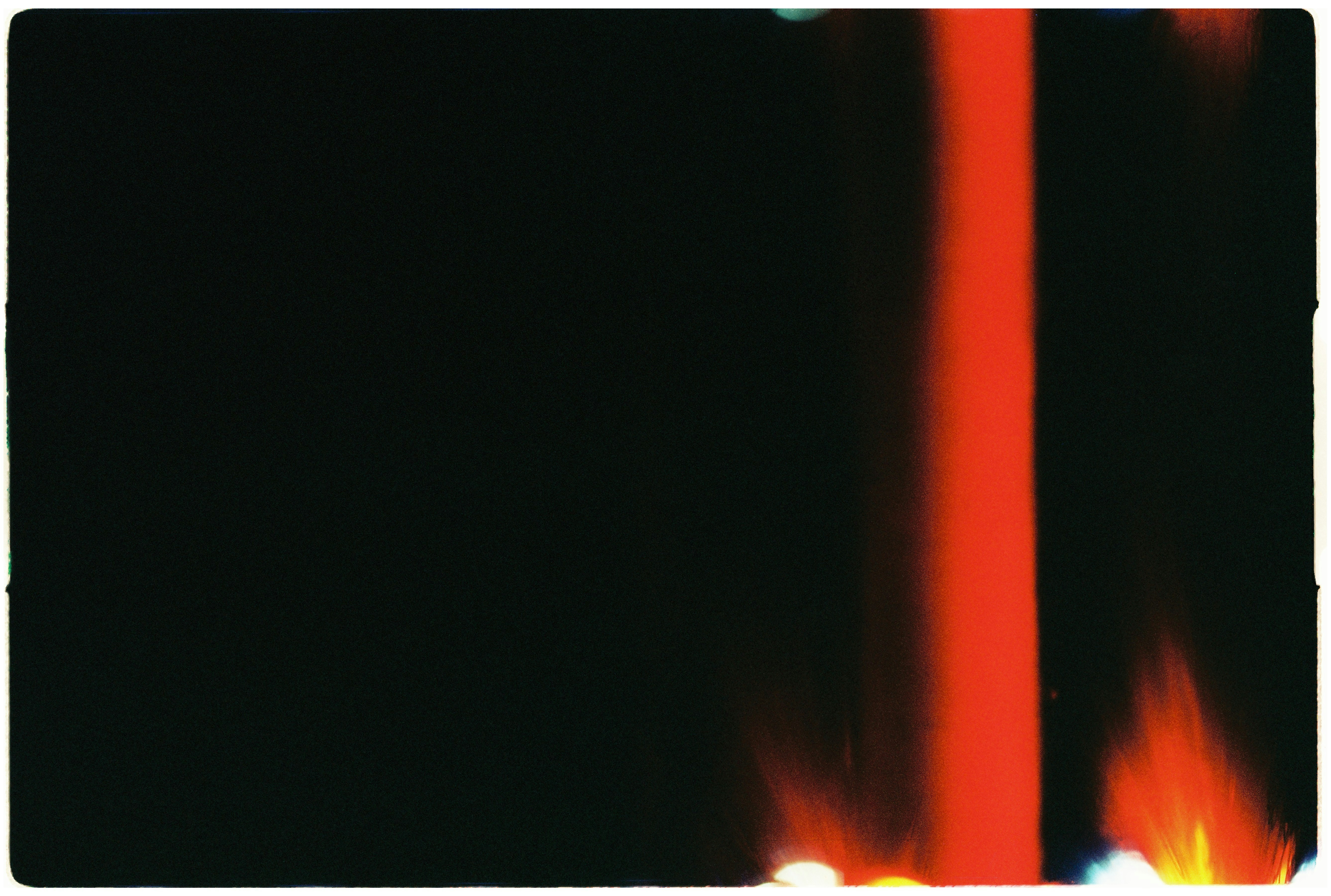 Vertical Flame: Neon Streaks Across a Dark Frame