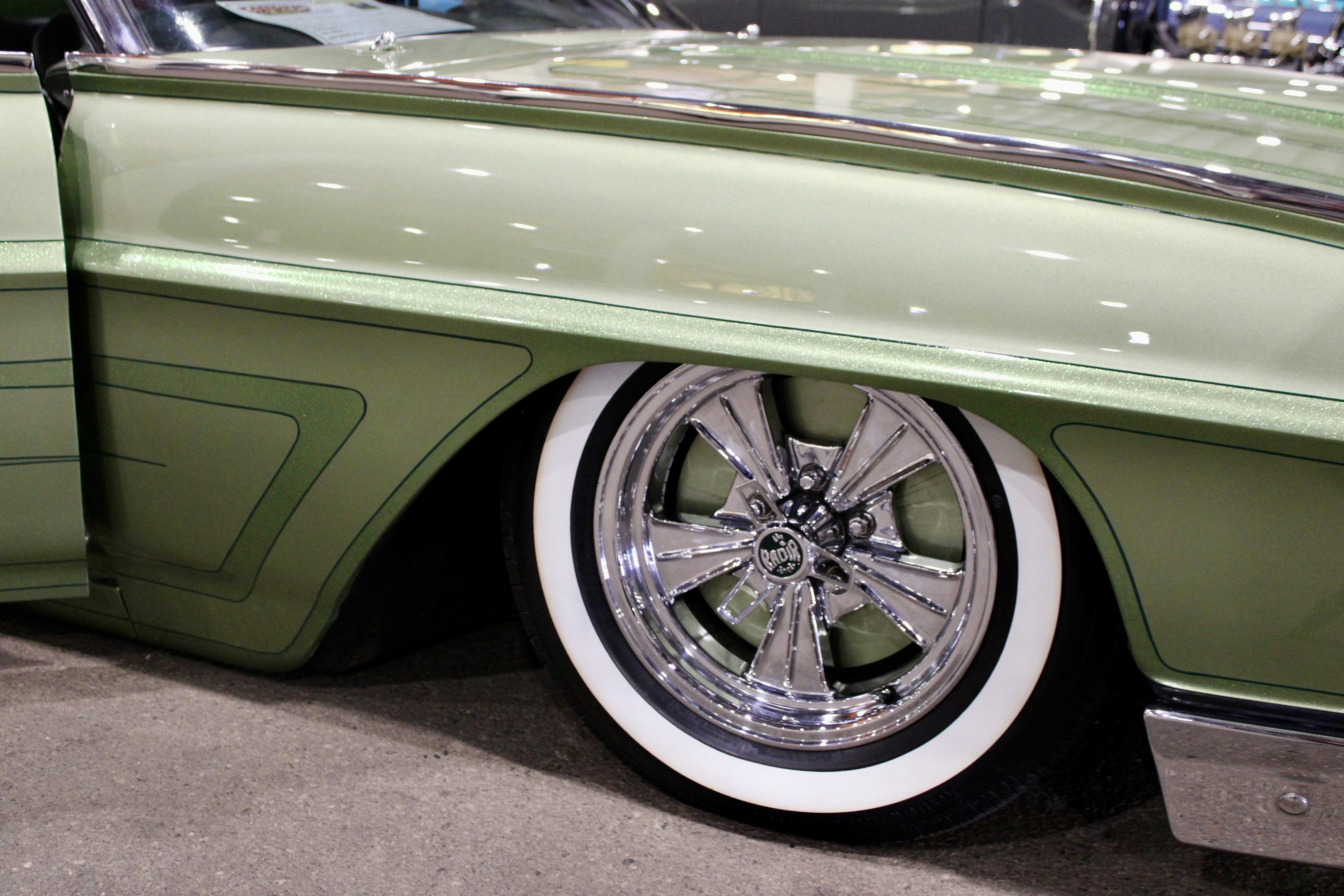 Green Classic: Chrome Wheel and Whitewall in a Parking Spotlight
