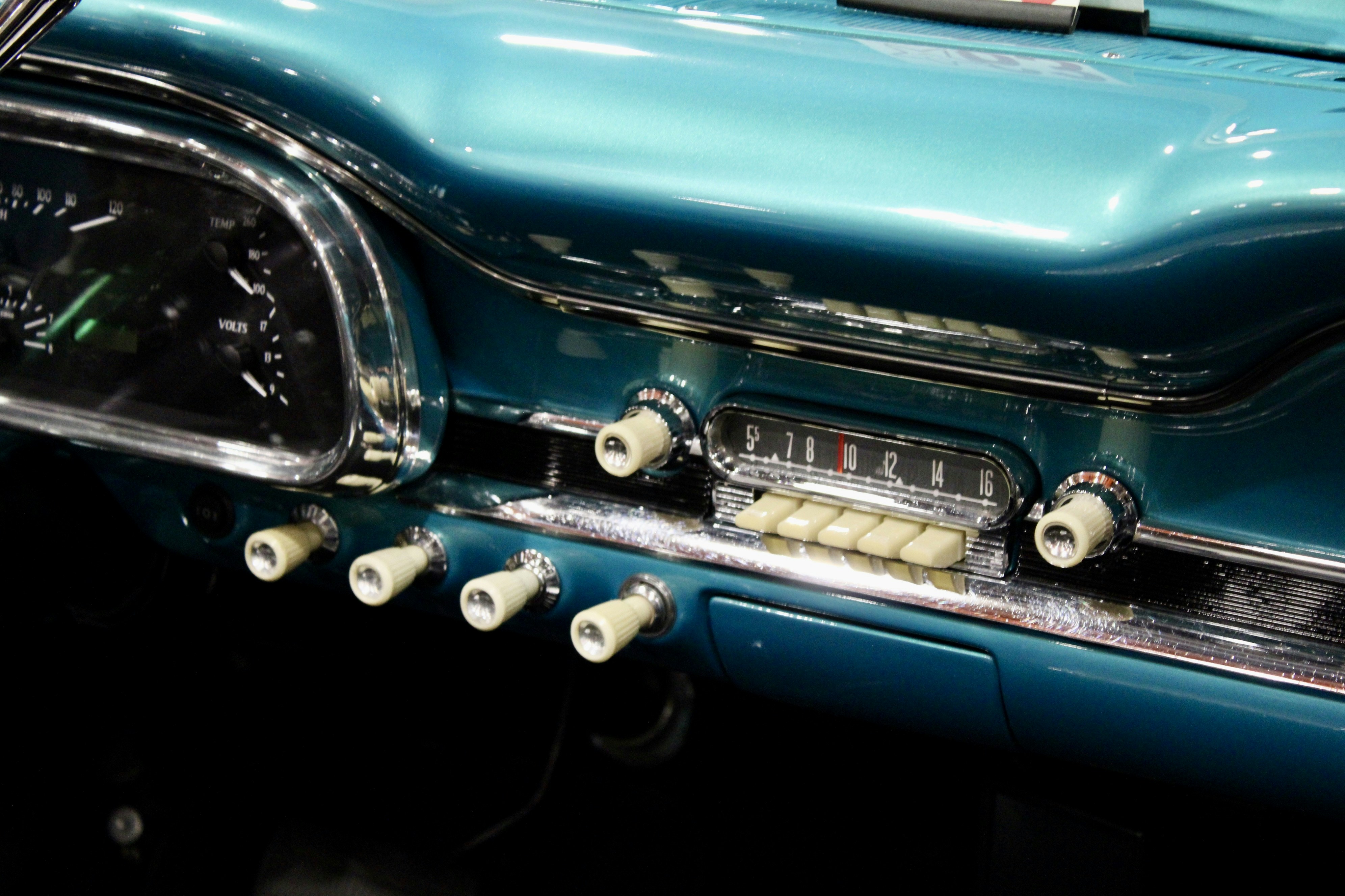 Chrome Knobs and Turquoise Dash: A Glimpse of Mid-Century Car Interior