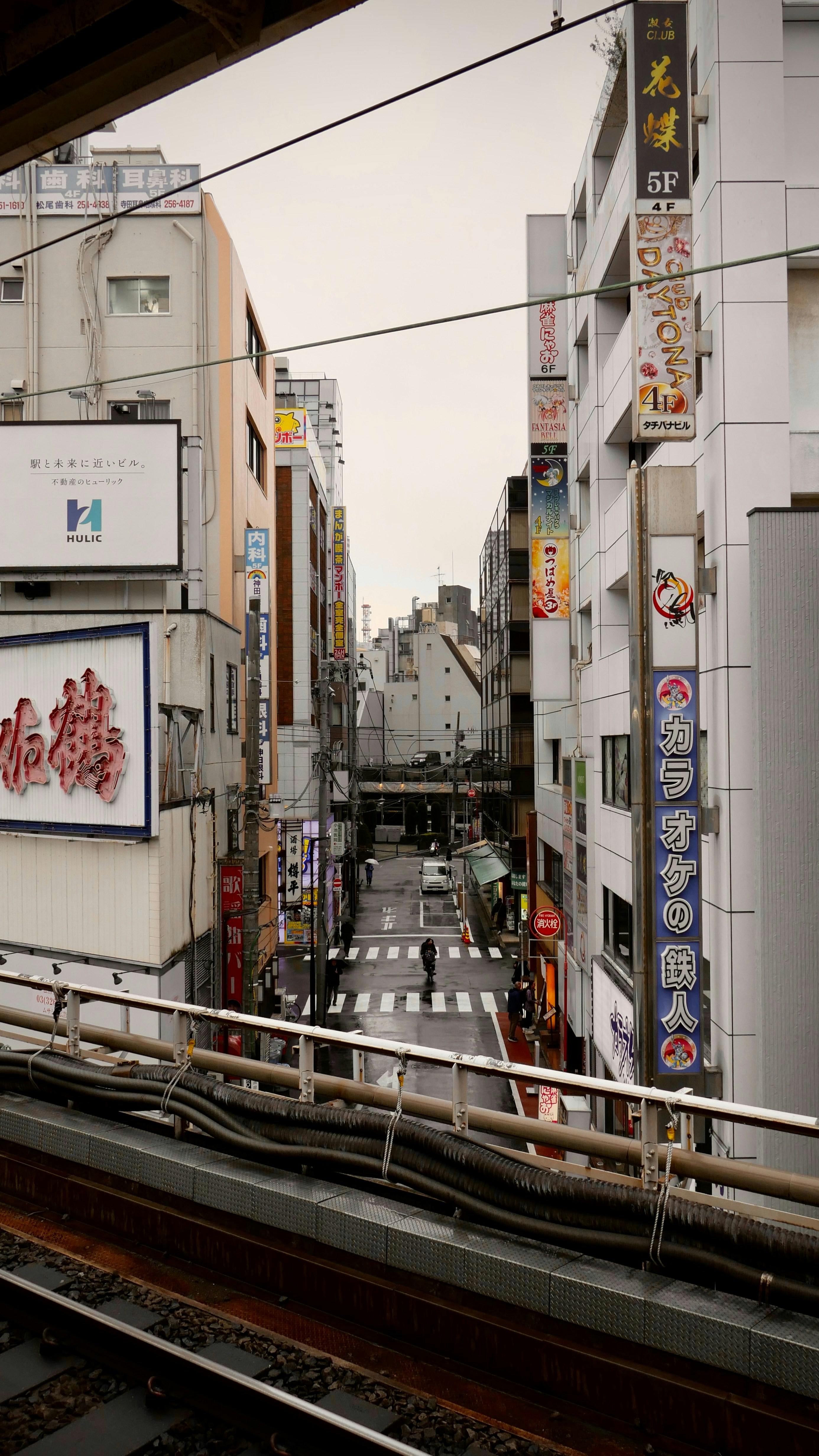City Rails: A Corridor of Neon Signage and Street Life