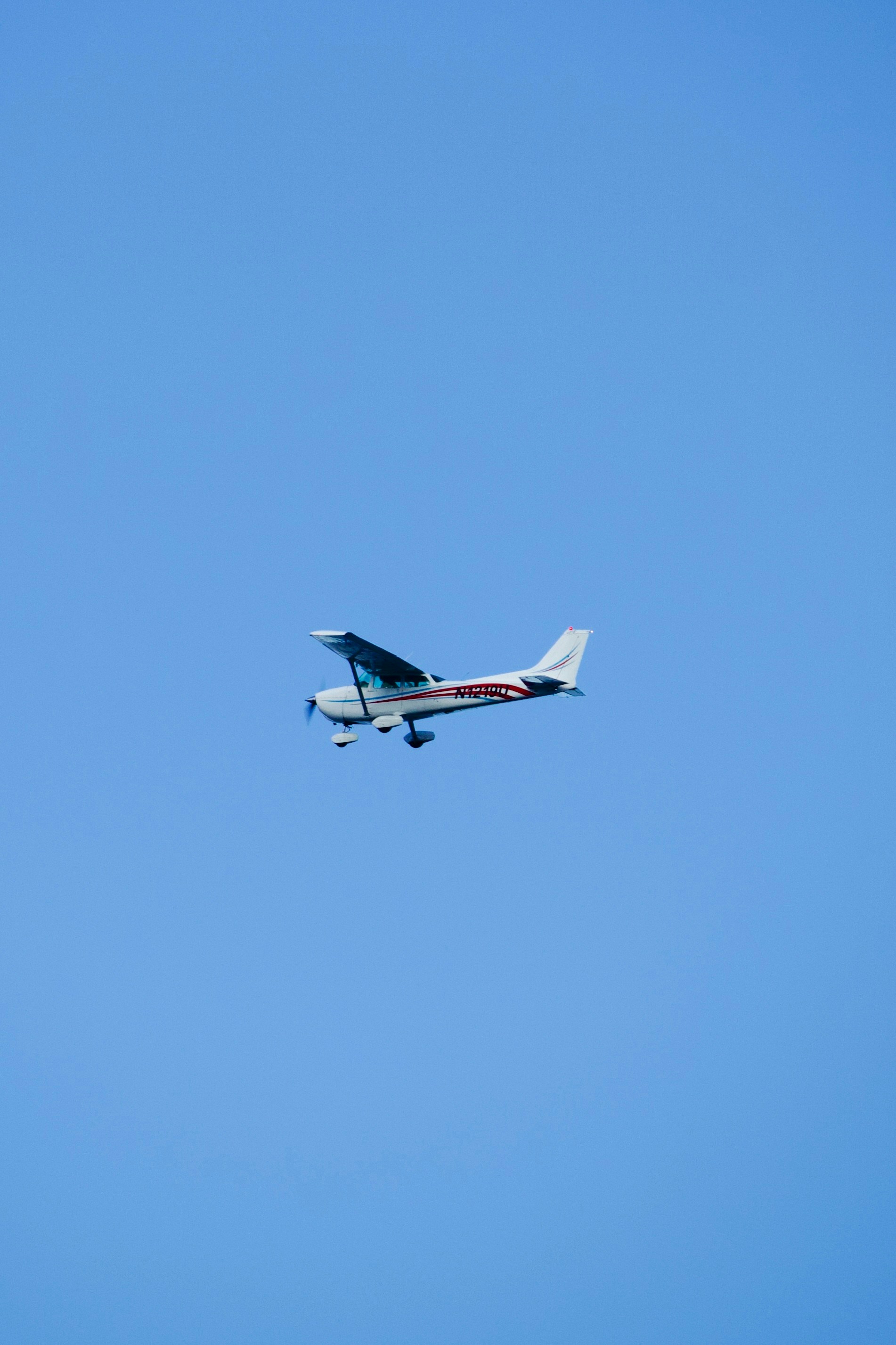 Blue Skies Arrival: A single-engine plane gliding through calm dawn