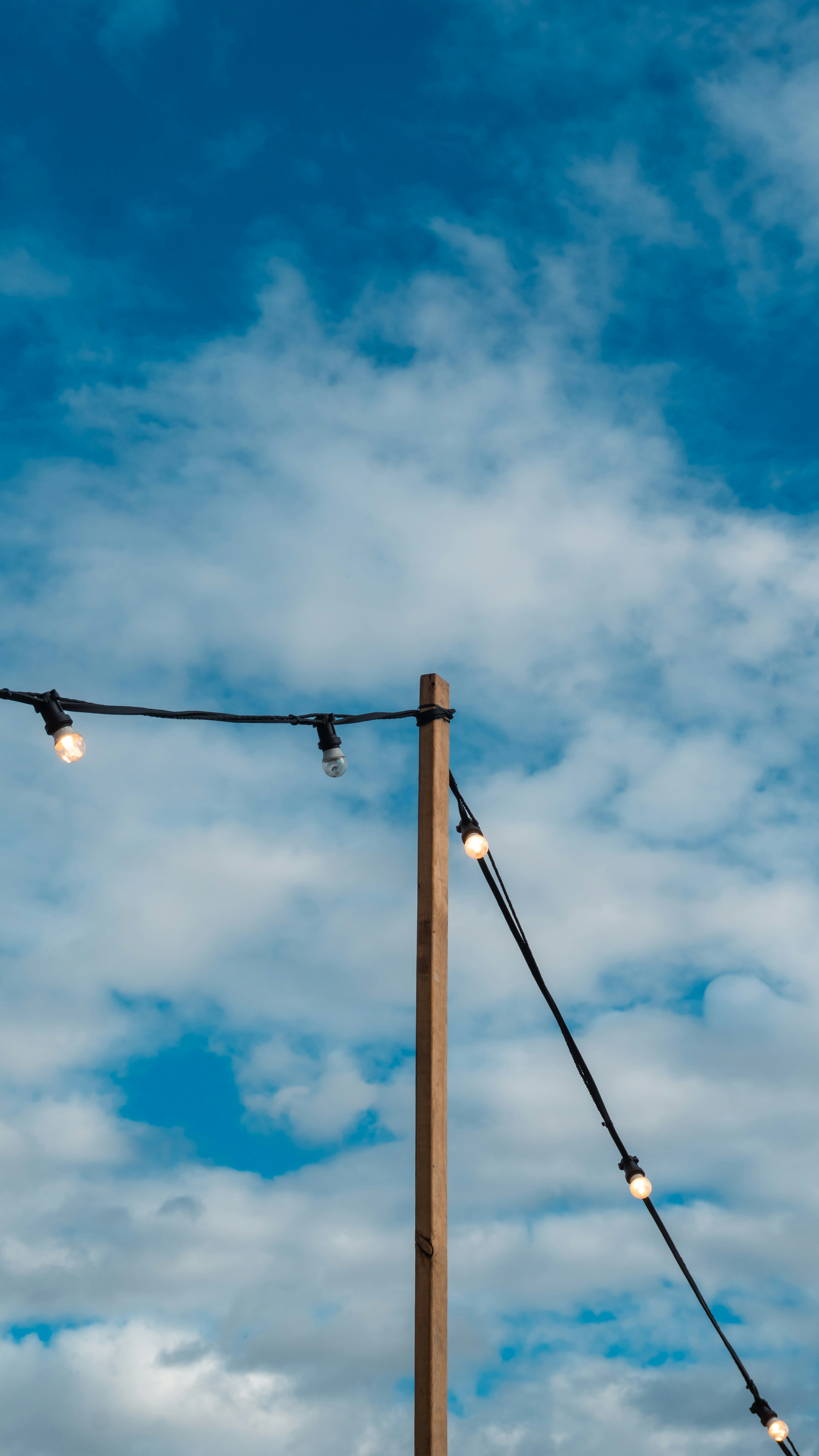 String of Lights Rising Above a Clear Blue Sky