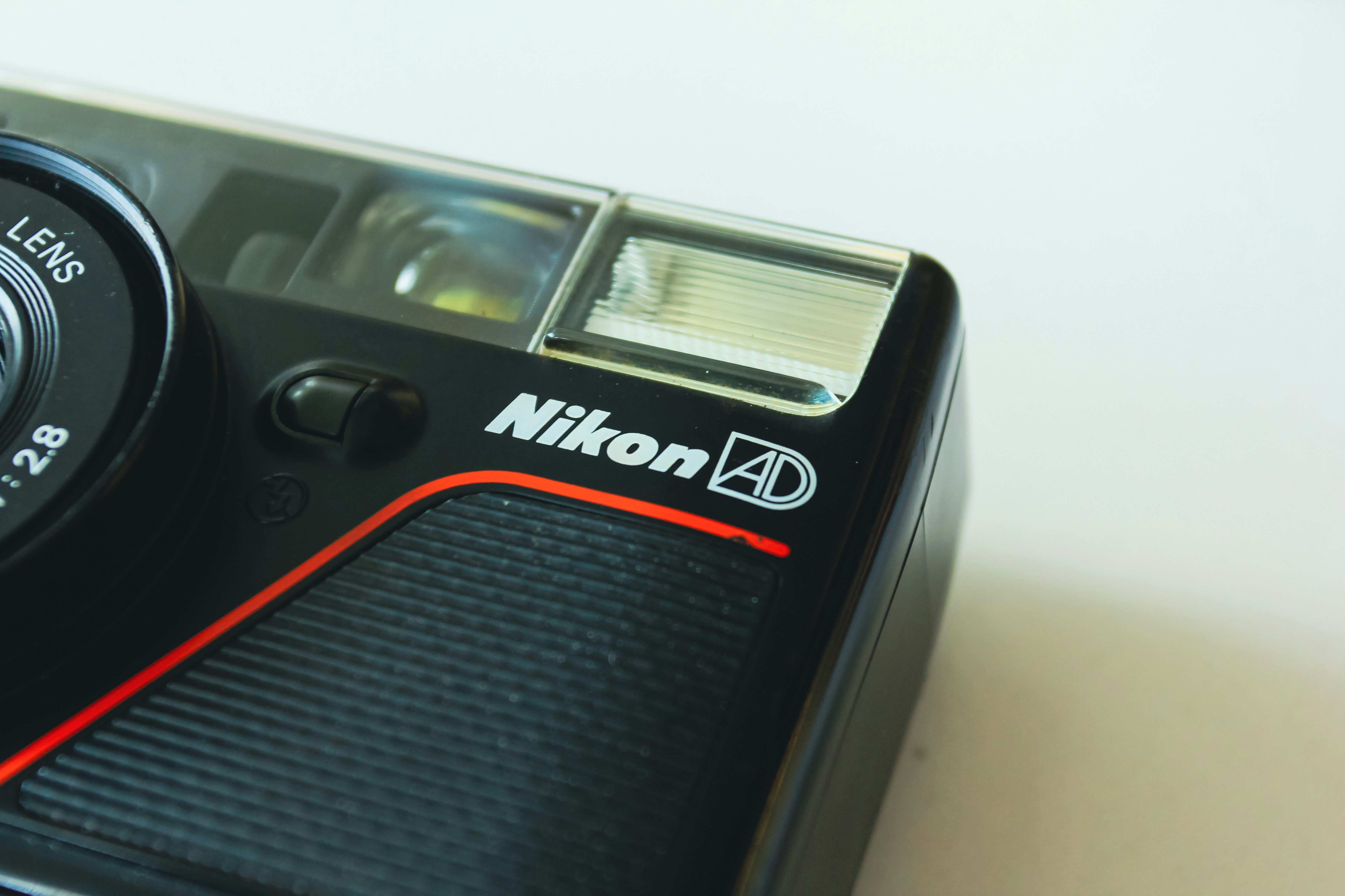 Nikon AD Compact: A Close-Up of the Brand Mark on a Retro Point-and-Shoot