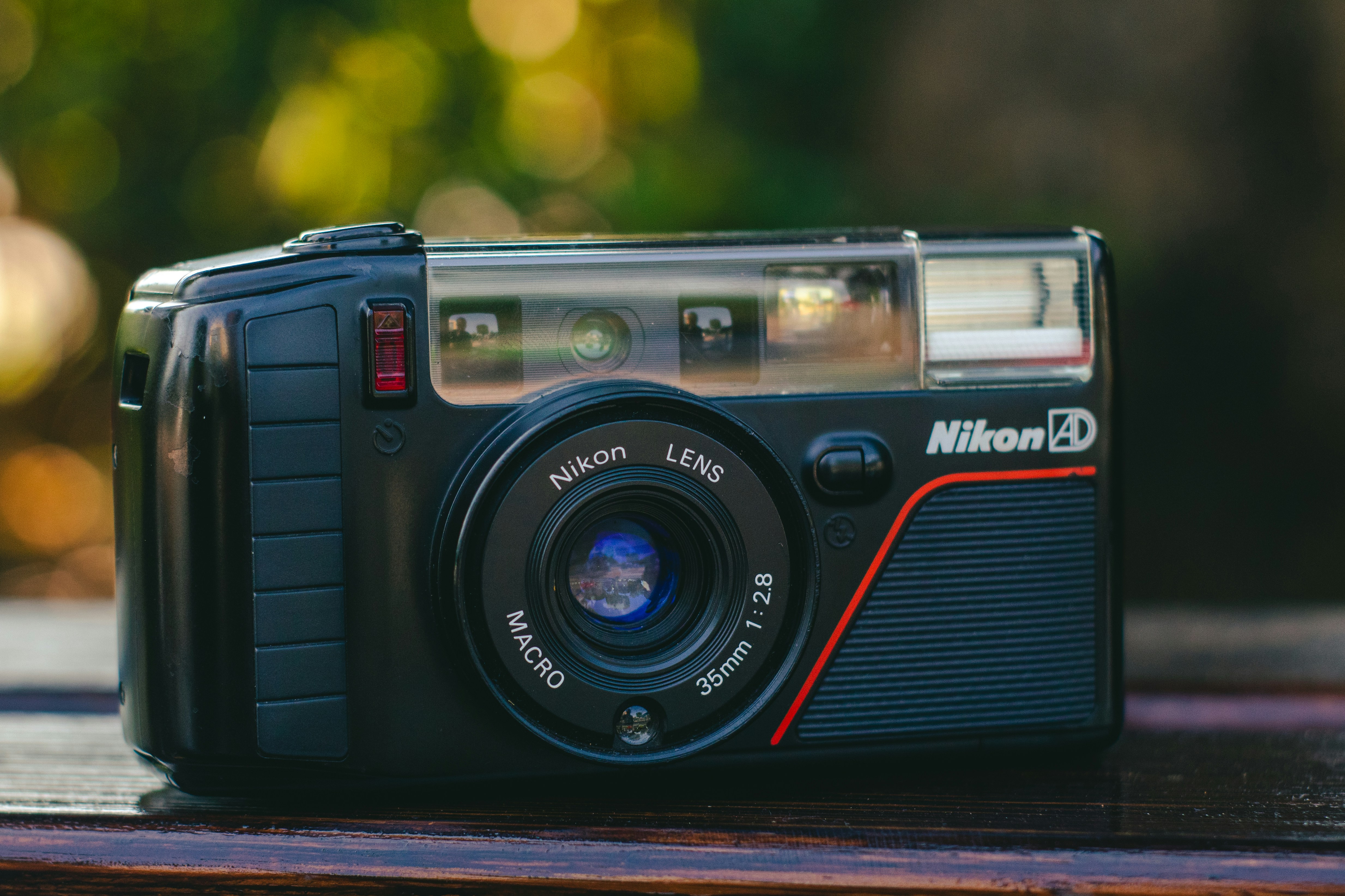 Polycarbonate Classic: A Retro Nikon Compact on a Wooden Stage