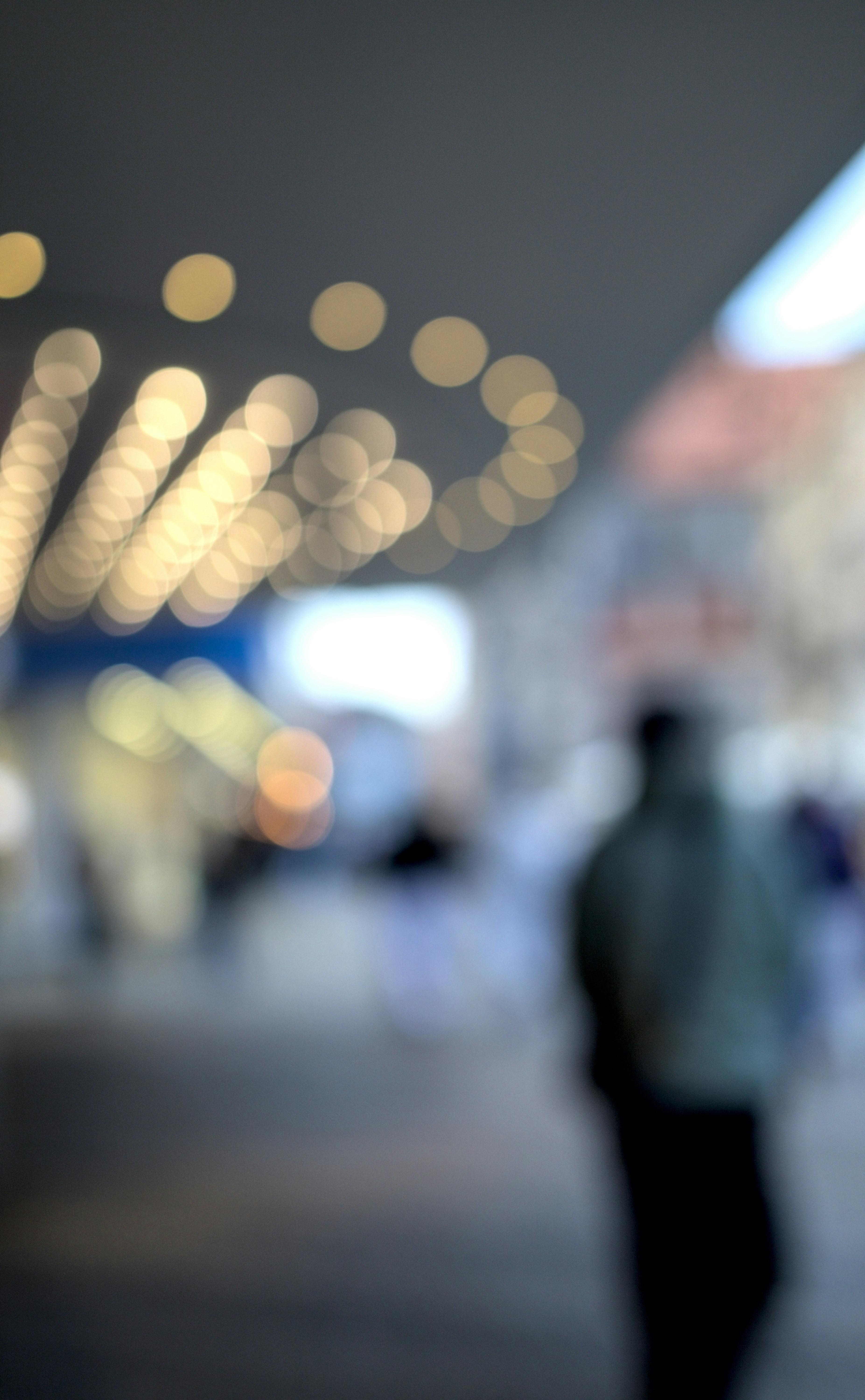 Blurred Terminal Echoes: A Lonely Visitor in Softly Lit Walkway
