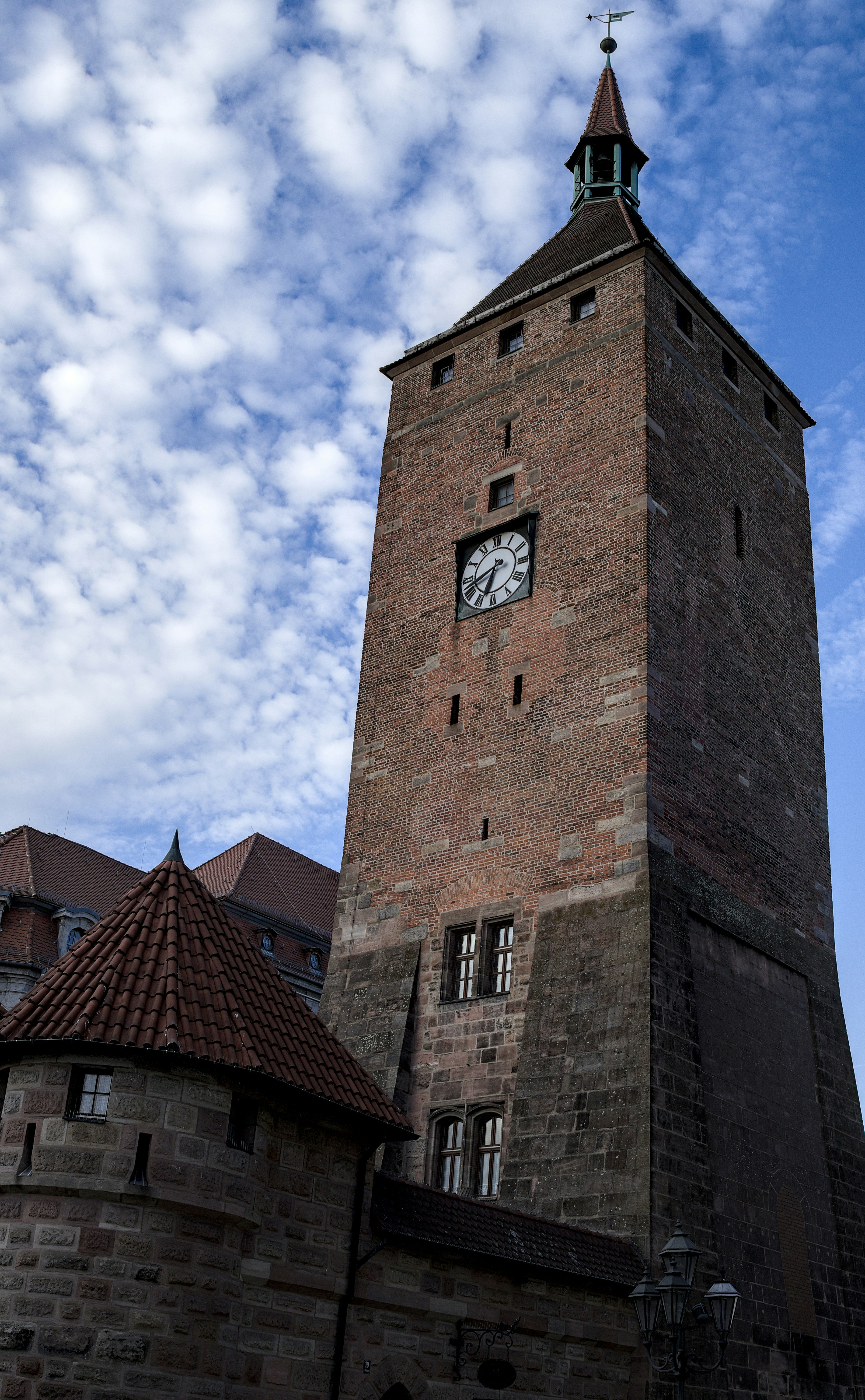 Clock Tower Ascending: A Brick Sentinels against a Sky Mosaic