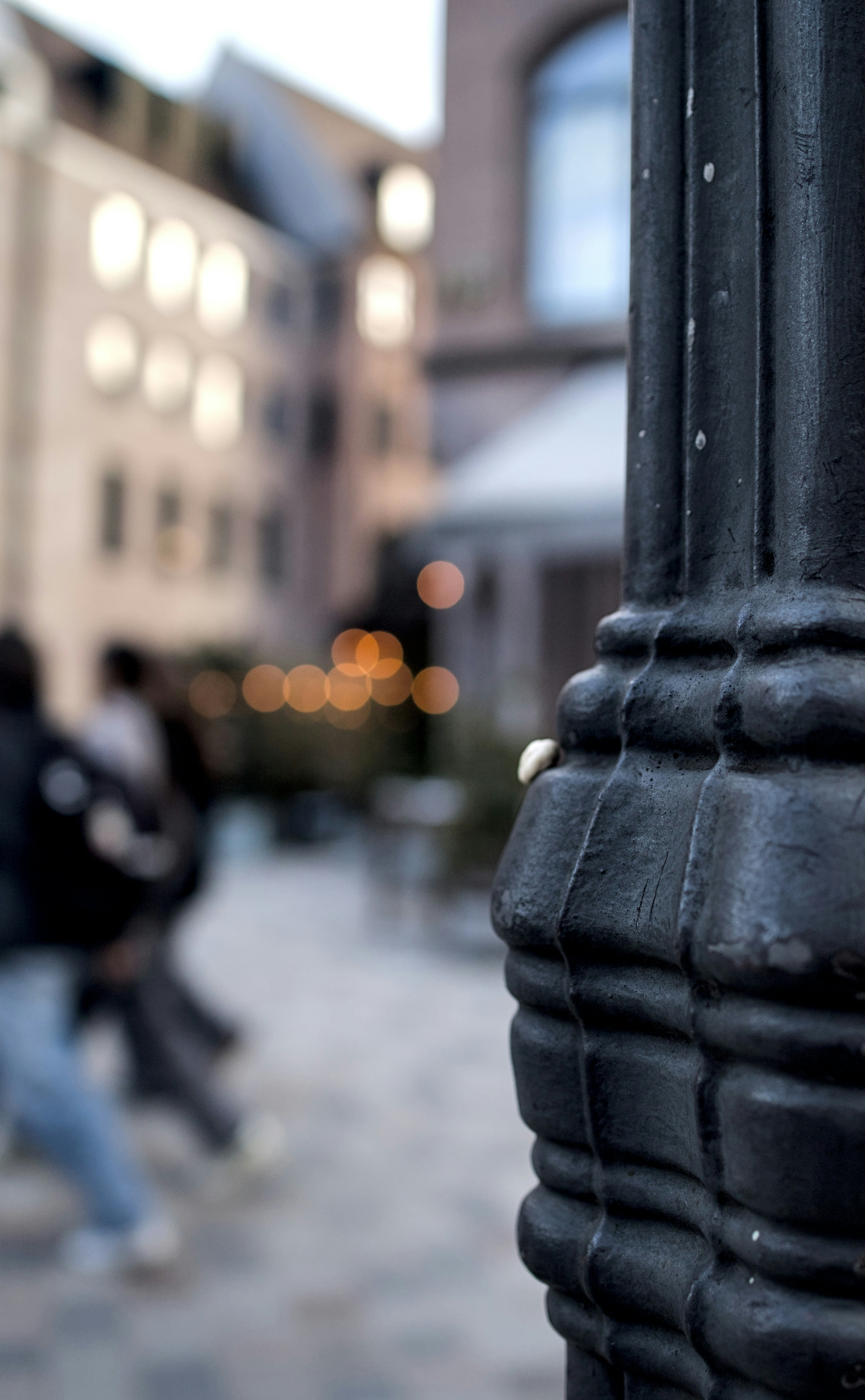 Iron pillar in focus: a close-up of urban texture and blurred background