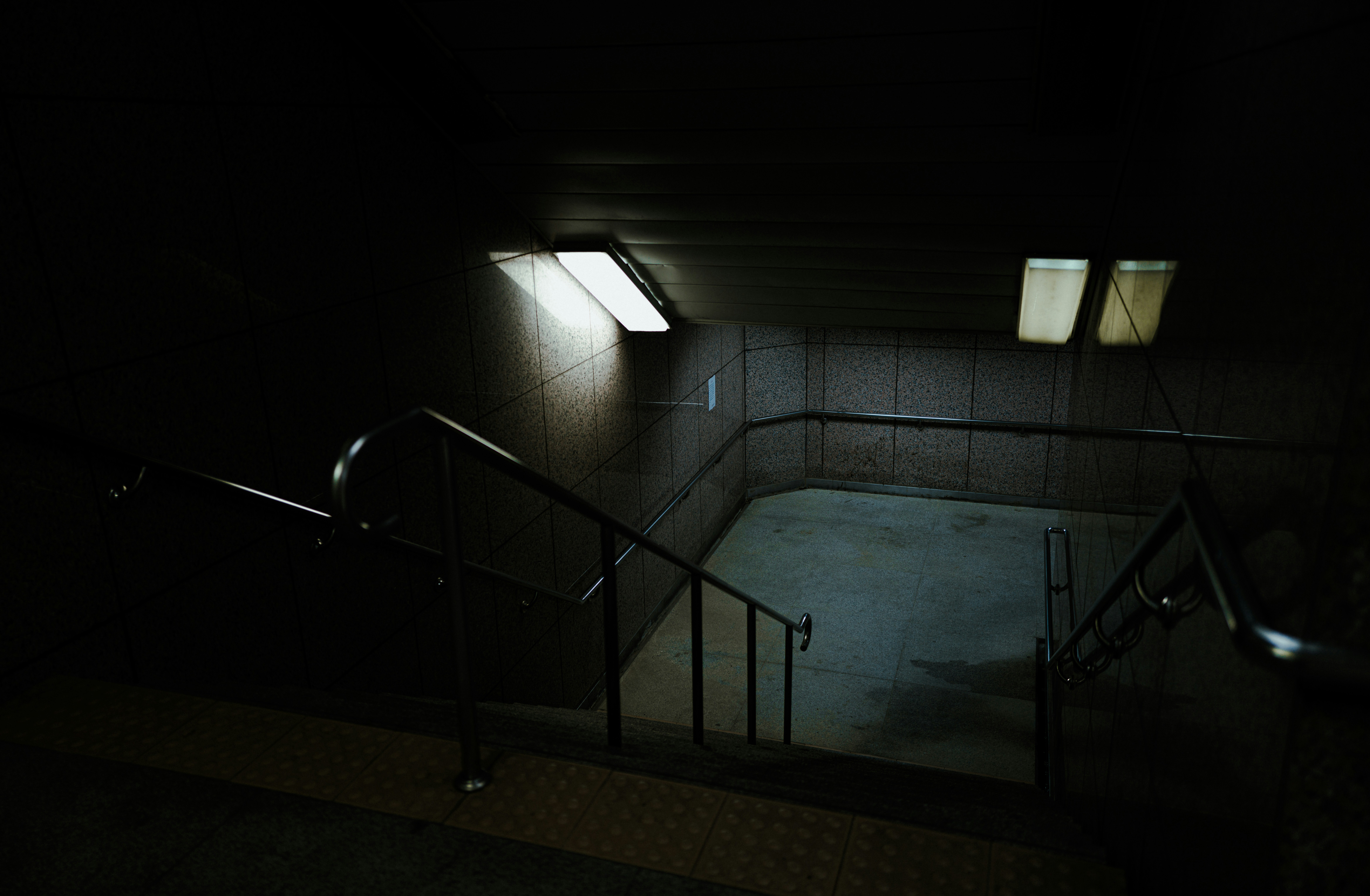 Midnight Descent: A Dim Staircase Beneath Fluorescent Echoes