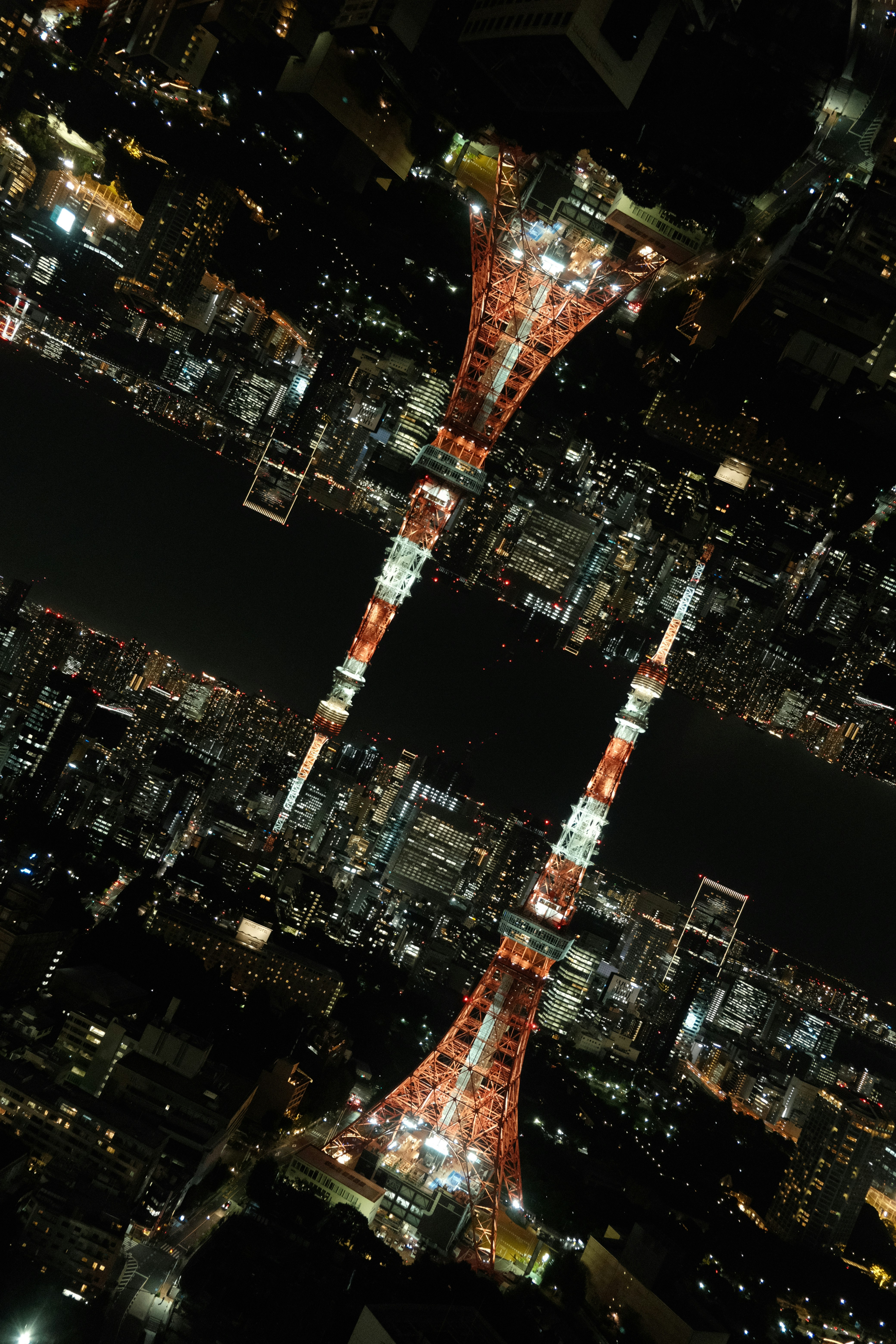 Nighttime Tokyo Tower: A mirrored city of lights
