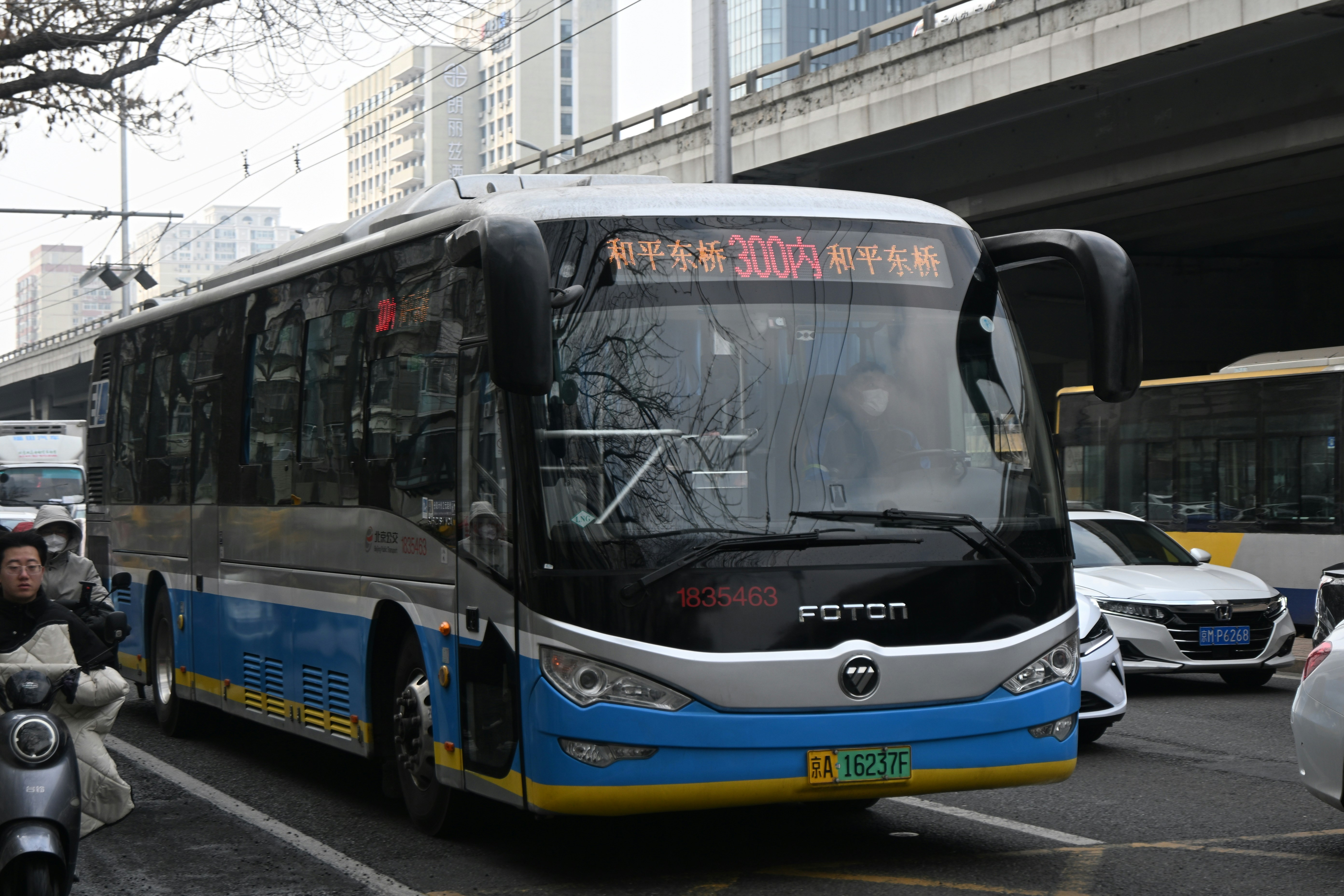 Blue-and-yellow city bus on a busy urban street