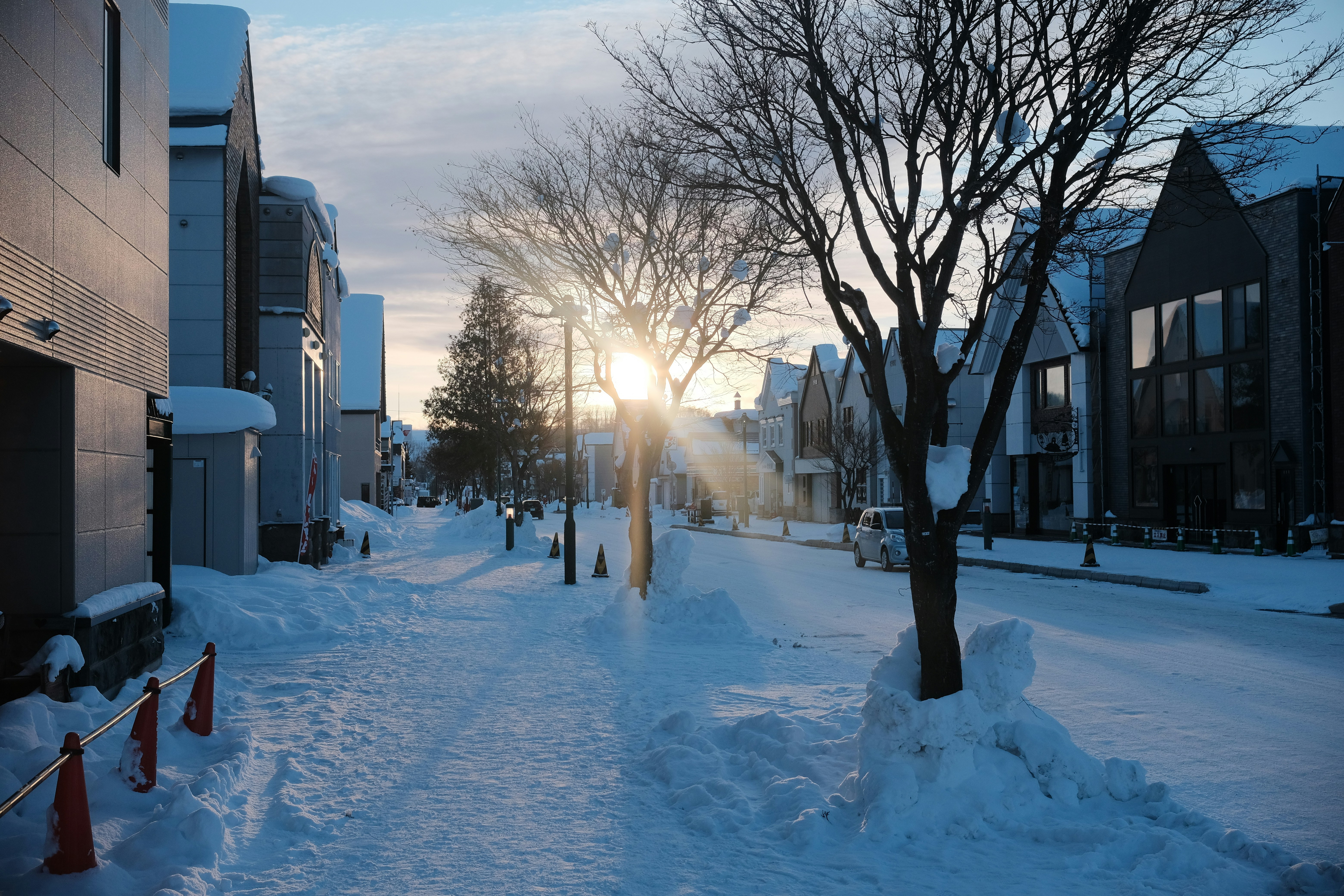 Sunburst Through Snow-Covered Street: A Quiet Winter Corridor