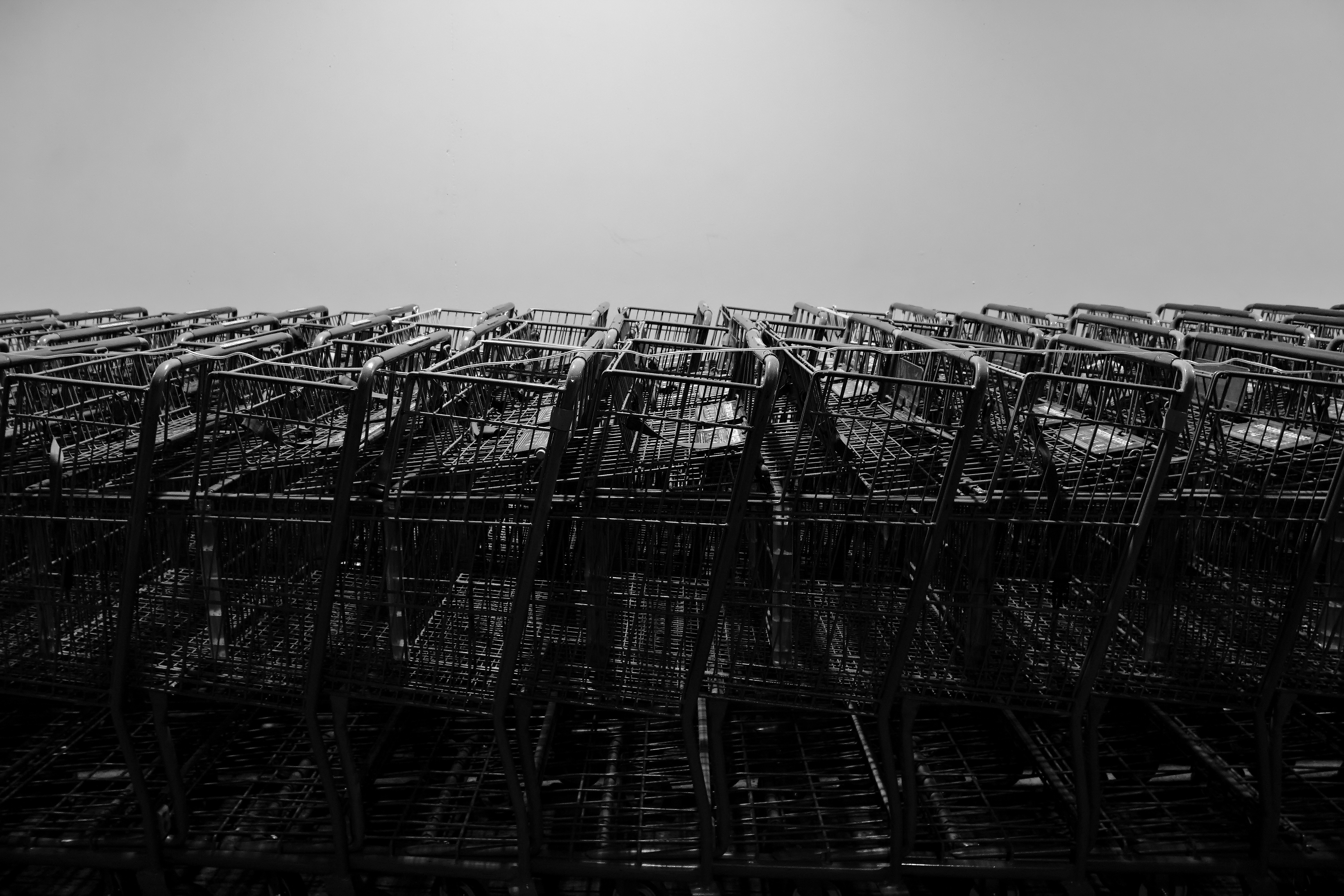 A Sea of Carts: Monochrome Grid of Trolleys Receding into Light