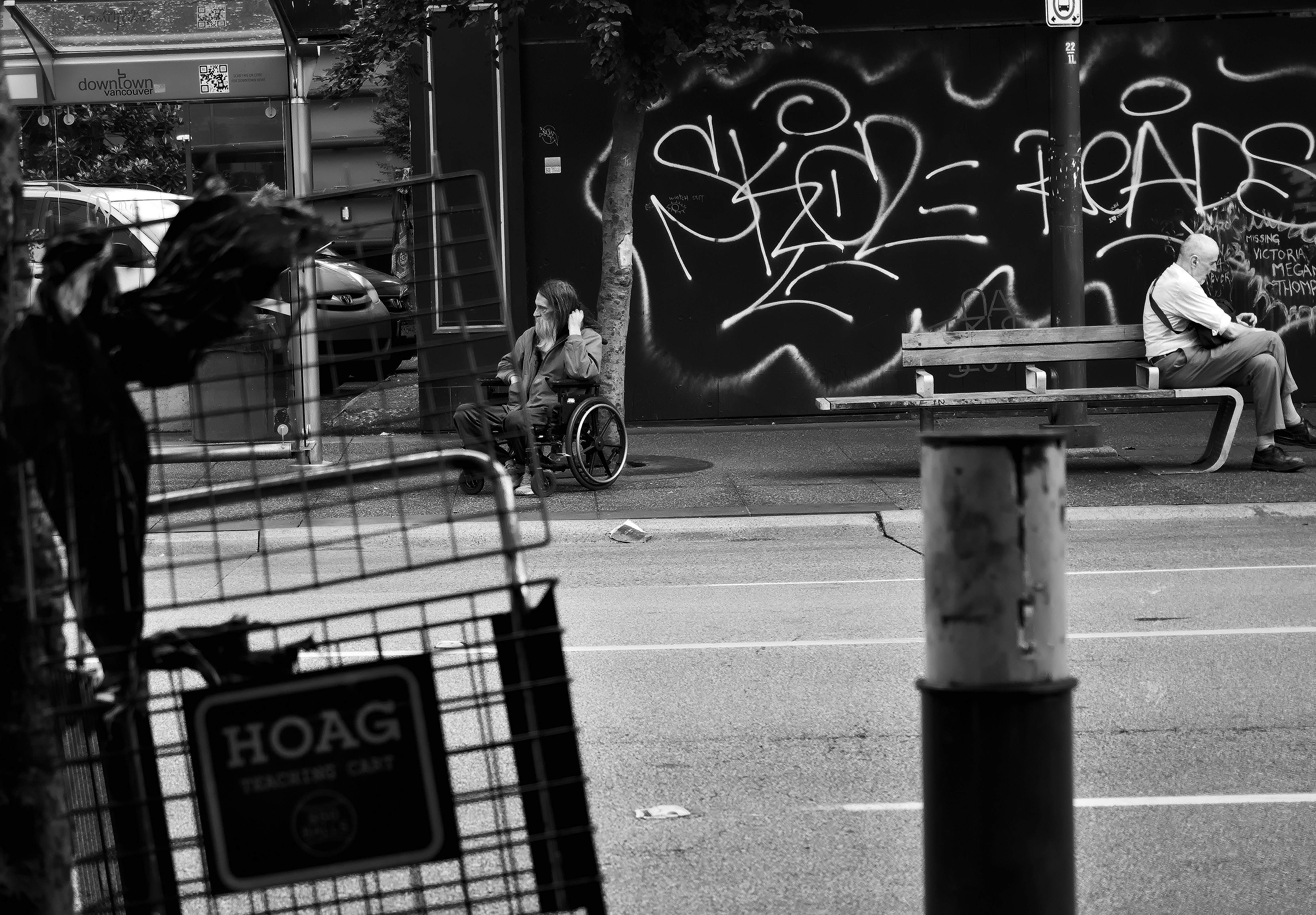 Urban Quiet: A Bench, a Wheelchair, and Graffiti at Dusk
