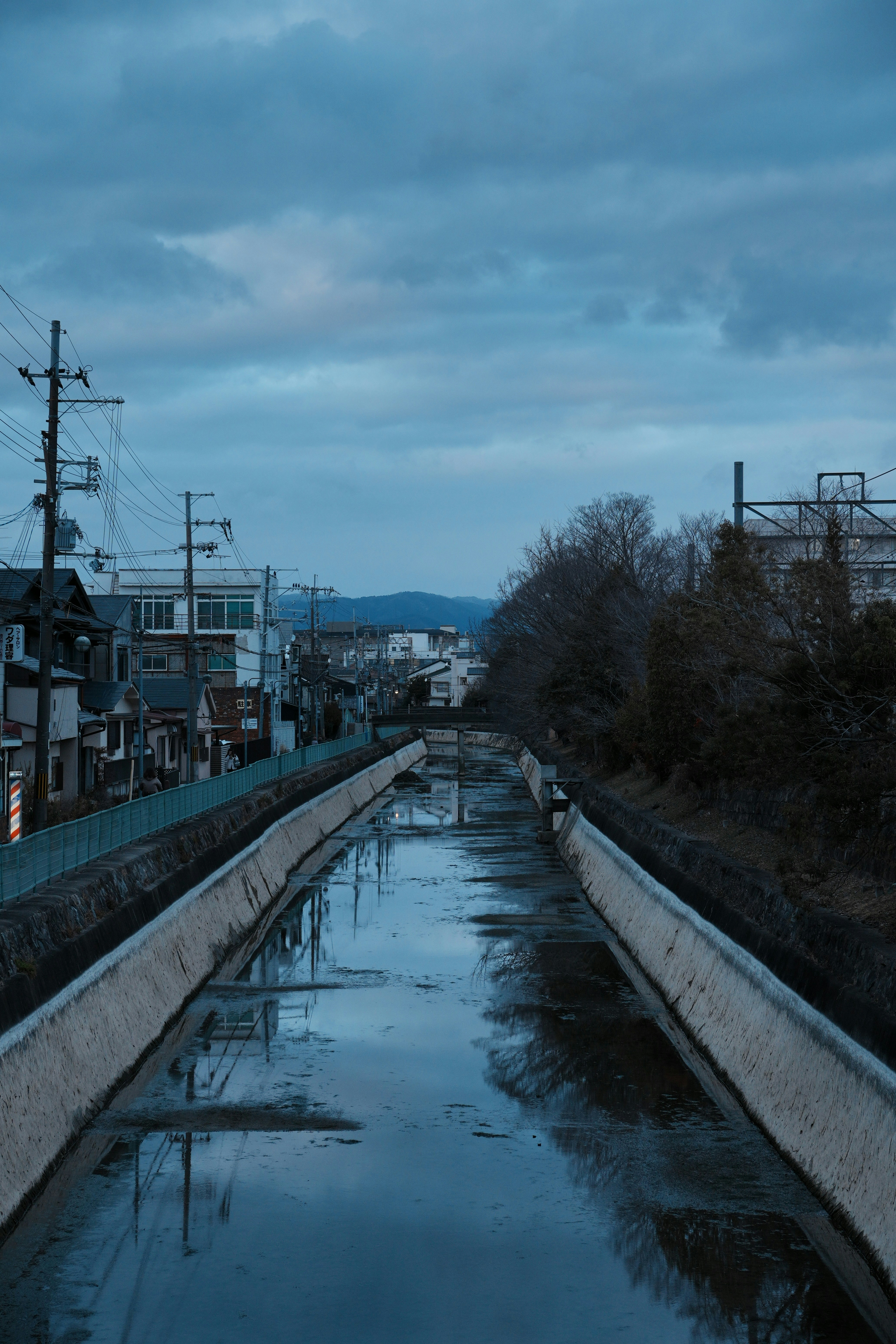 Overcast Canal Corridor: Quiet Street Reflections