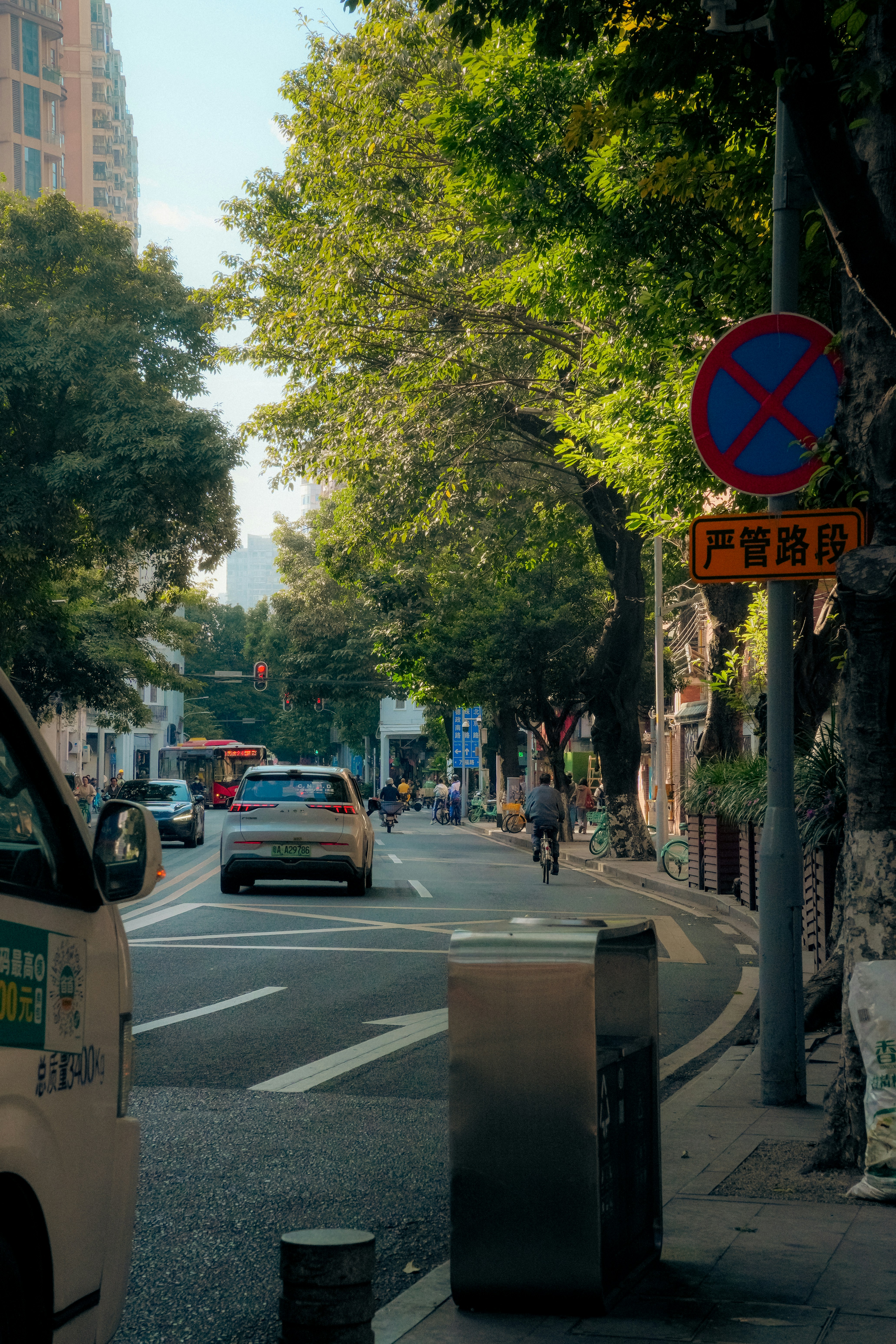 City Street Corridor: Dappled Light and Moving Focus