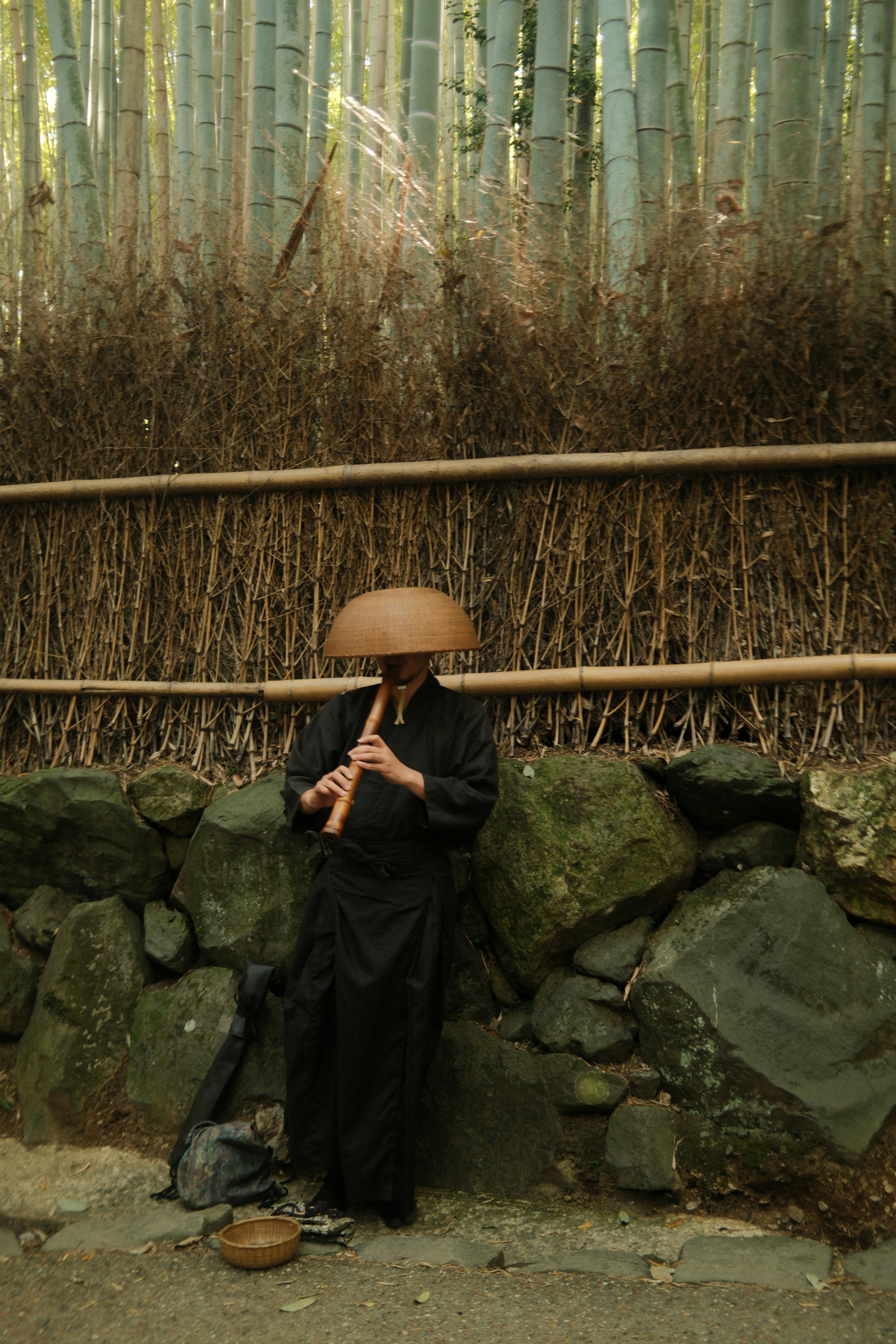 Mantle of Shade: A Monk with a Straw Hat Quietly Plays